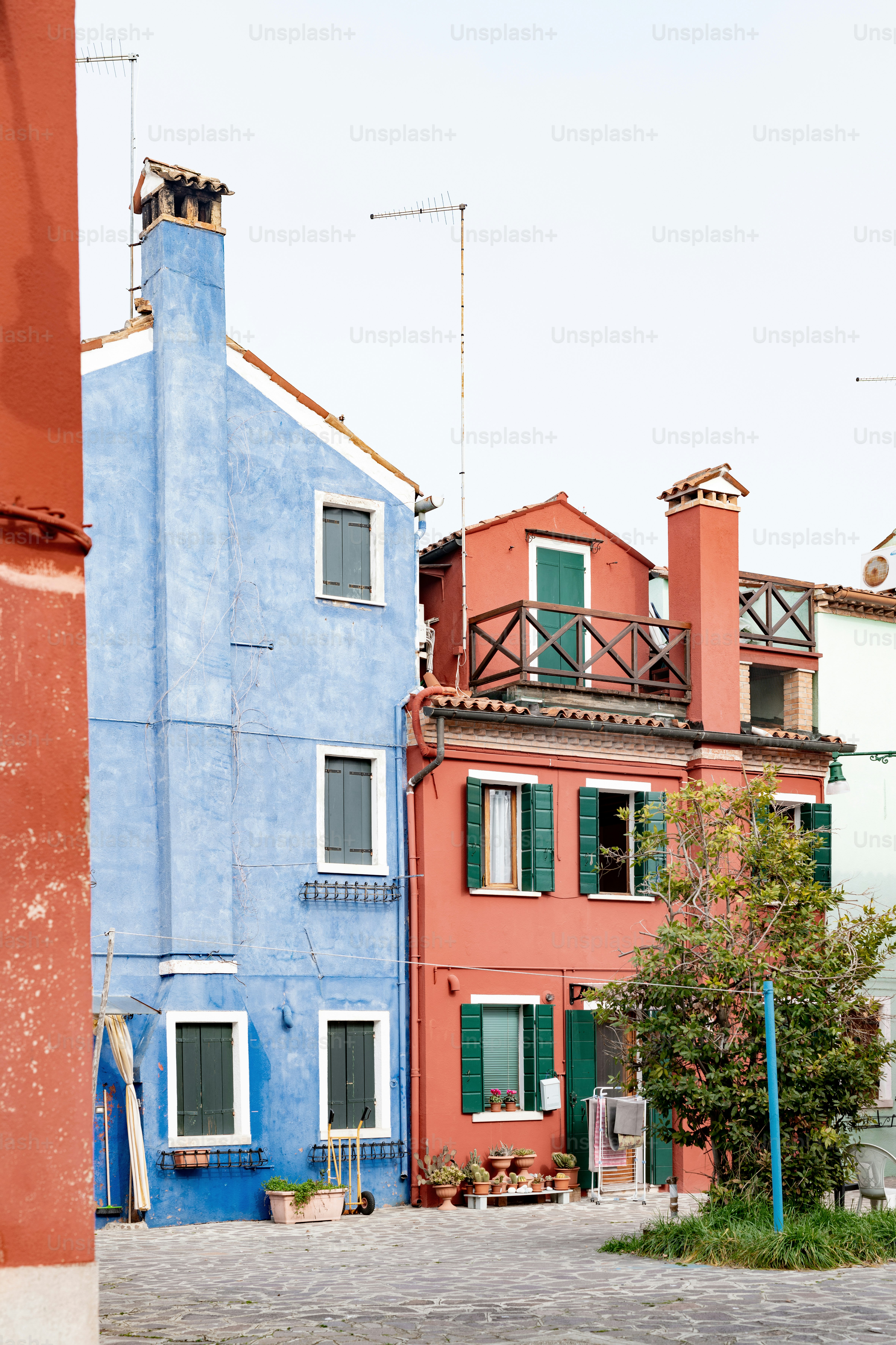 A blue building with a clock on the top of it photo – Italy Image on ...