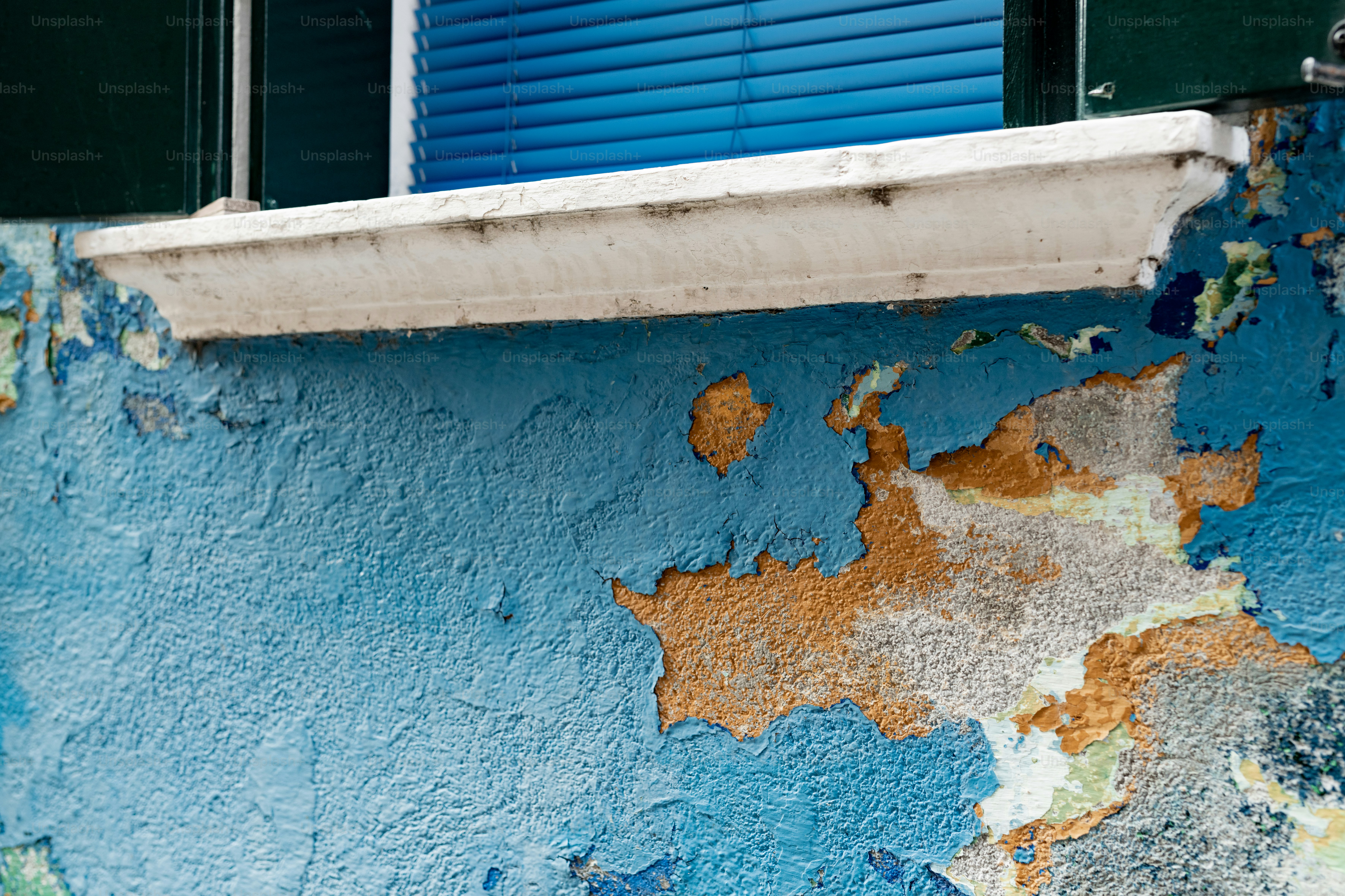 A blue building with a clock on the top of it photo – Burano Image on ...