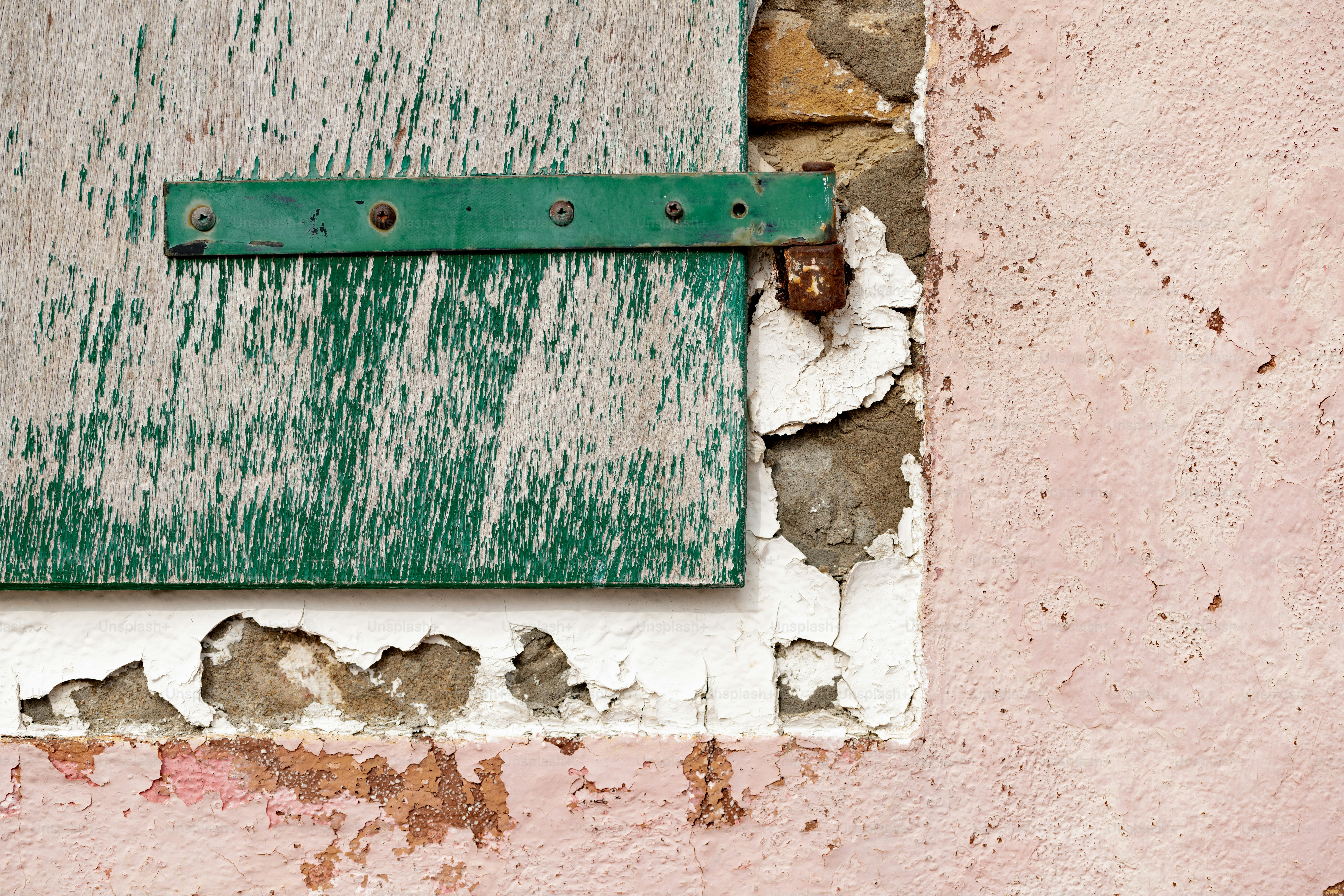 A close up of a green and white window on a wall photo – Break wall ...