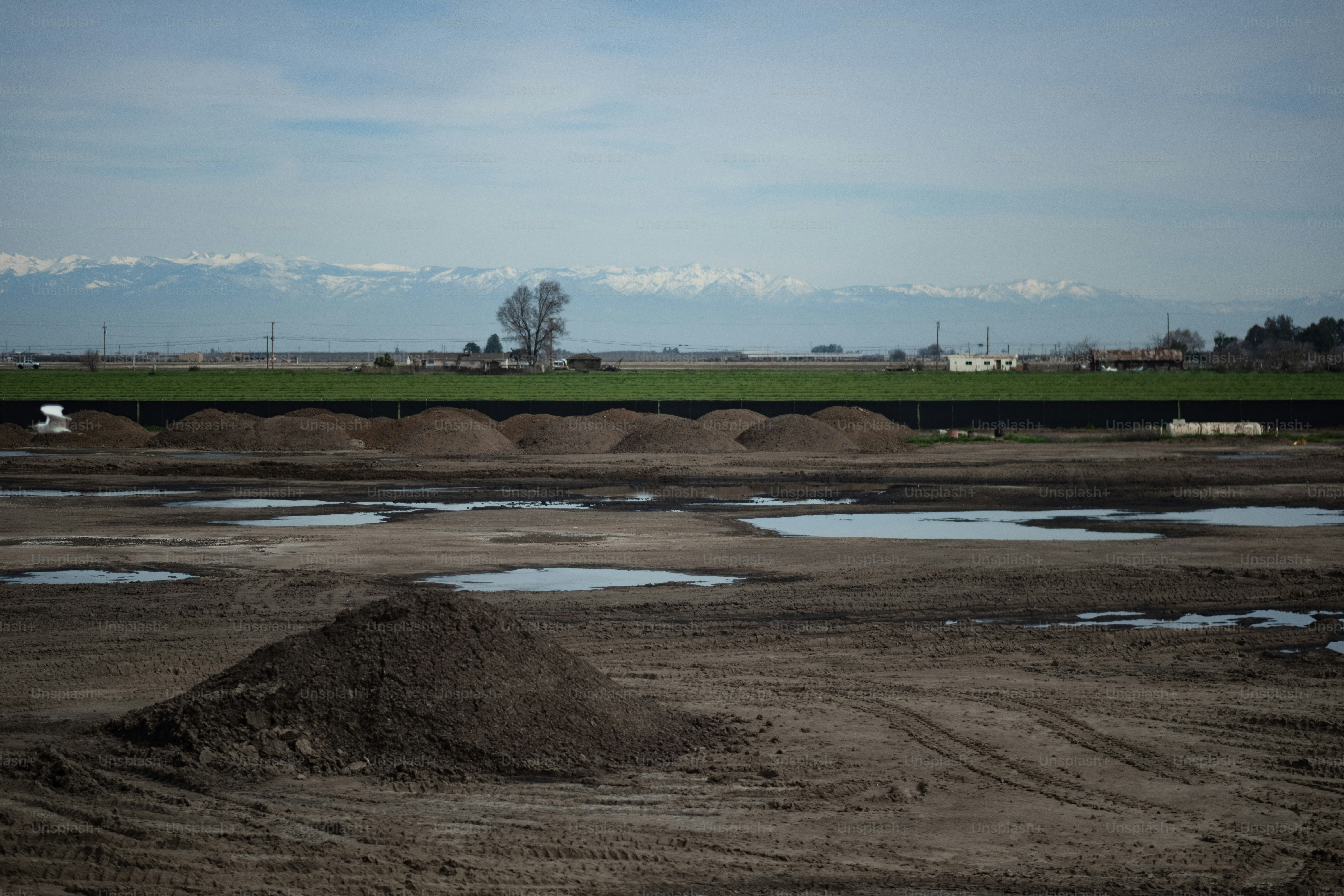 A large pile of dirt next to a field photo – Agriculture Image on Unsplash