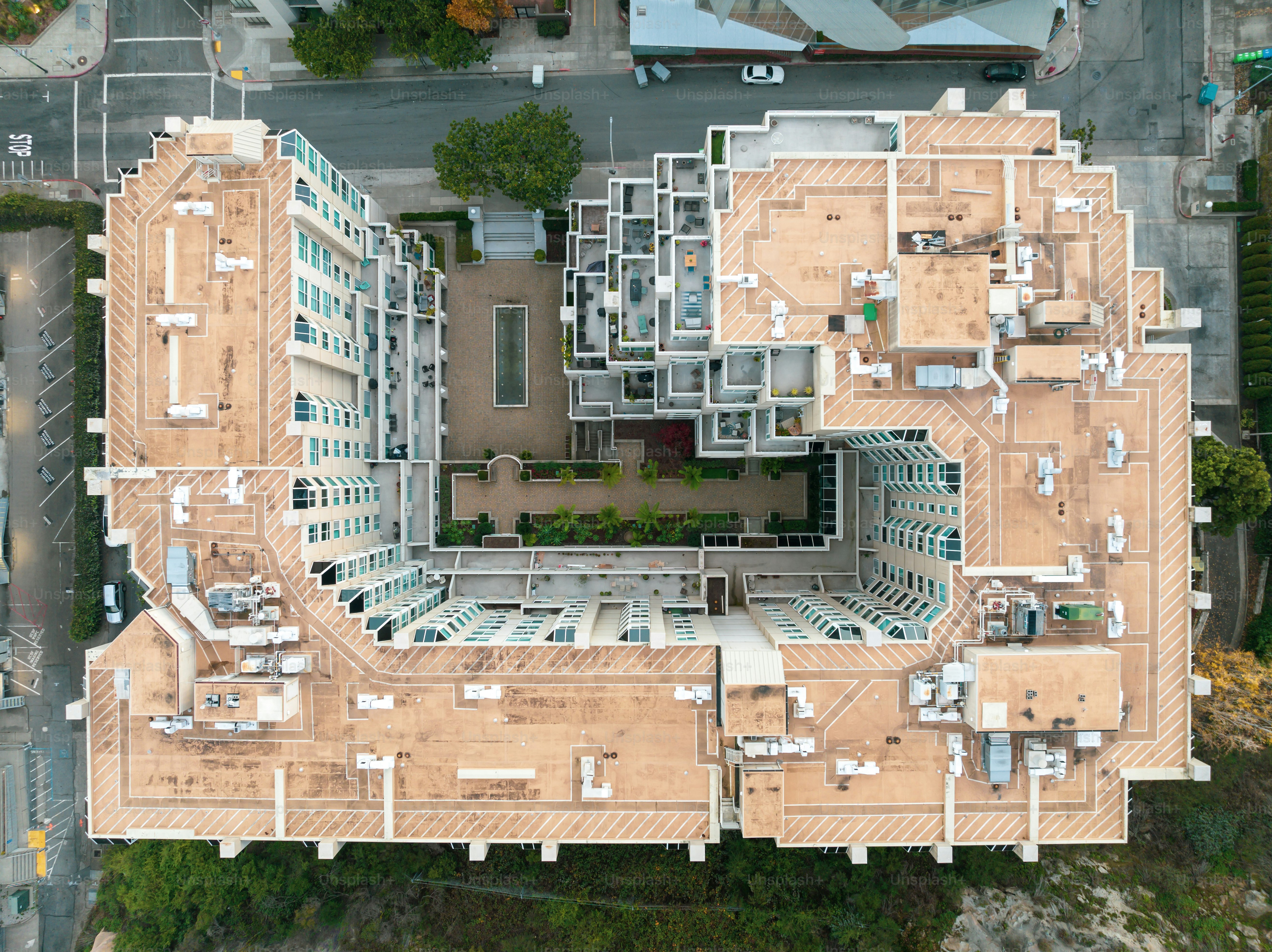 An aerial view of a building with multiple floors photo – Building ...