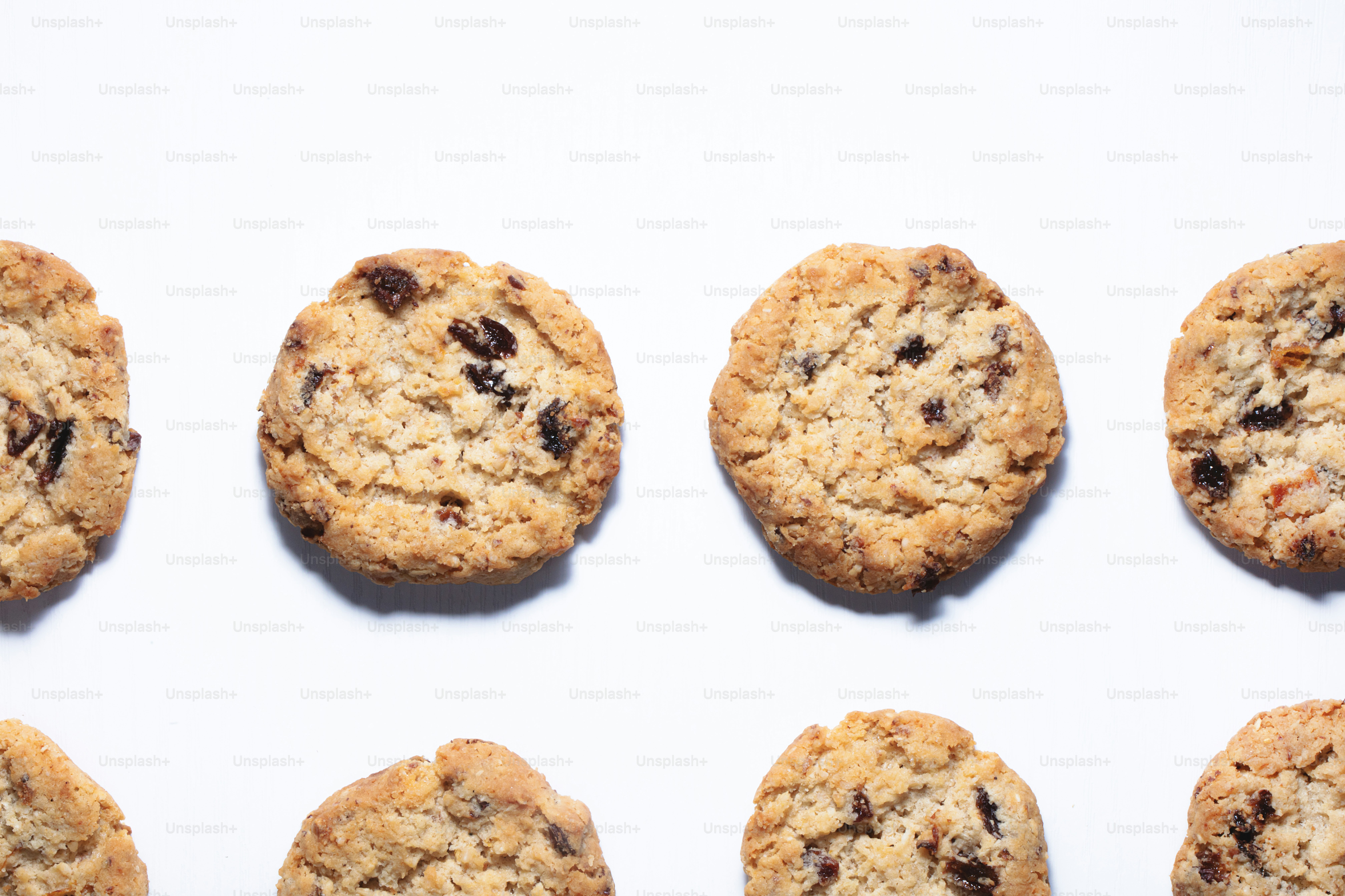 Nine cookies arranged in a row on a white surface photo – Cookies Image ...