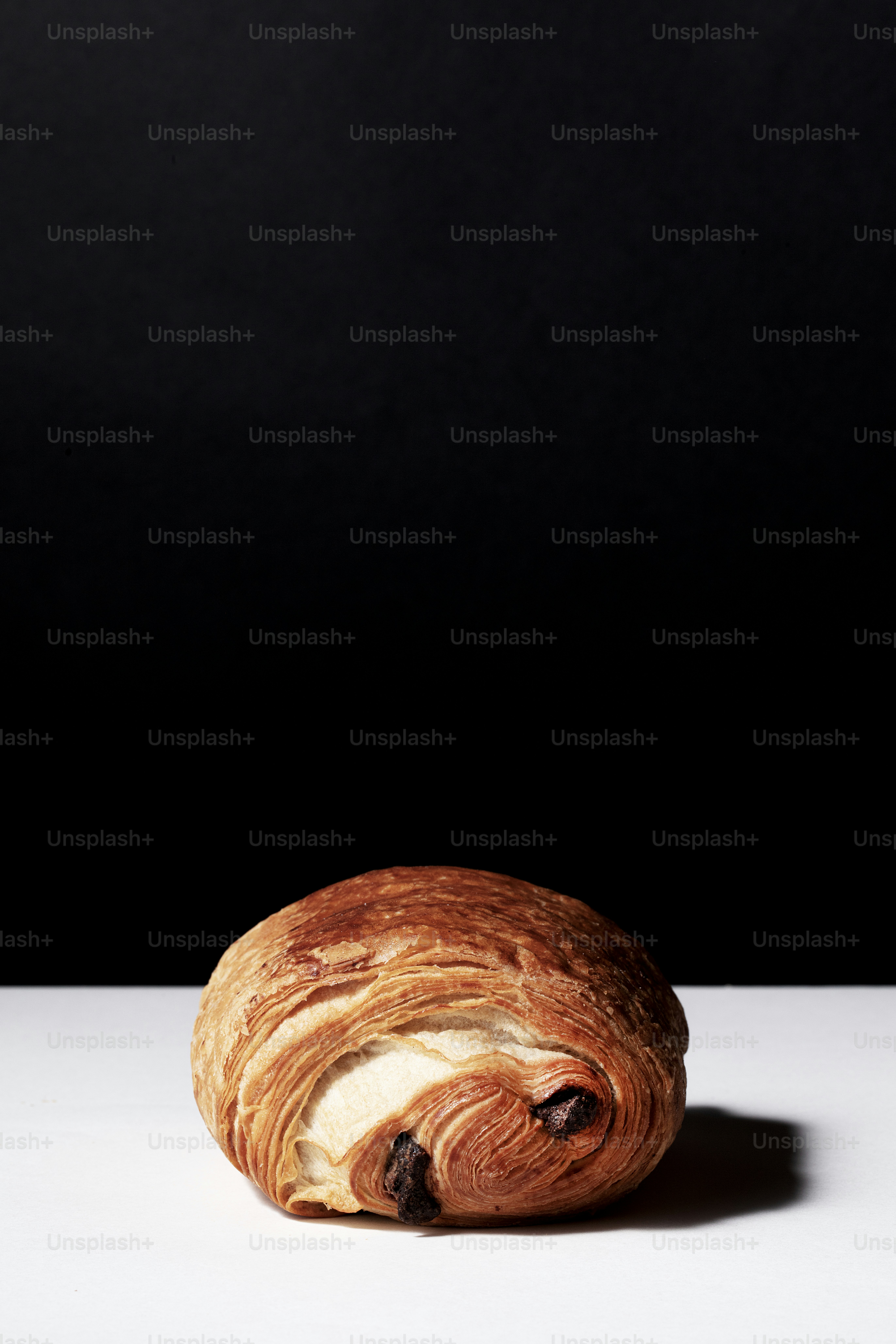 A croissant sitting on top of a white table photo – Food Image on Unsplash