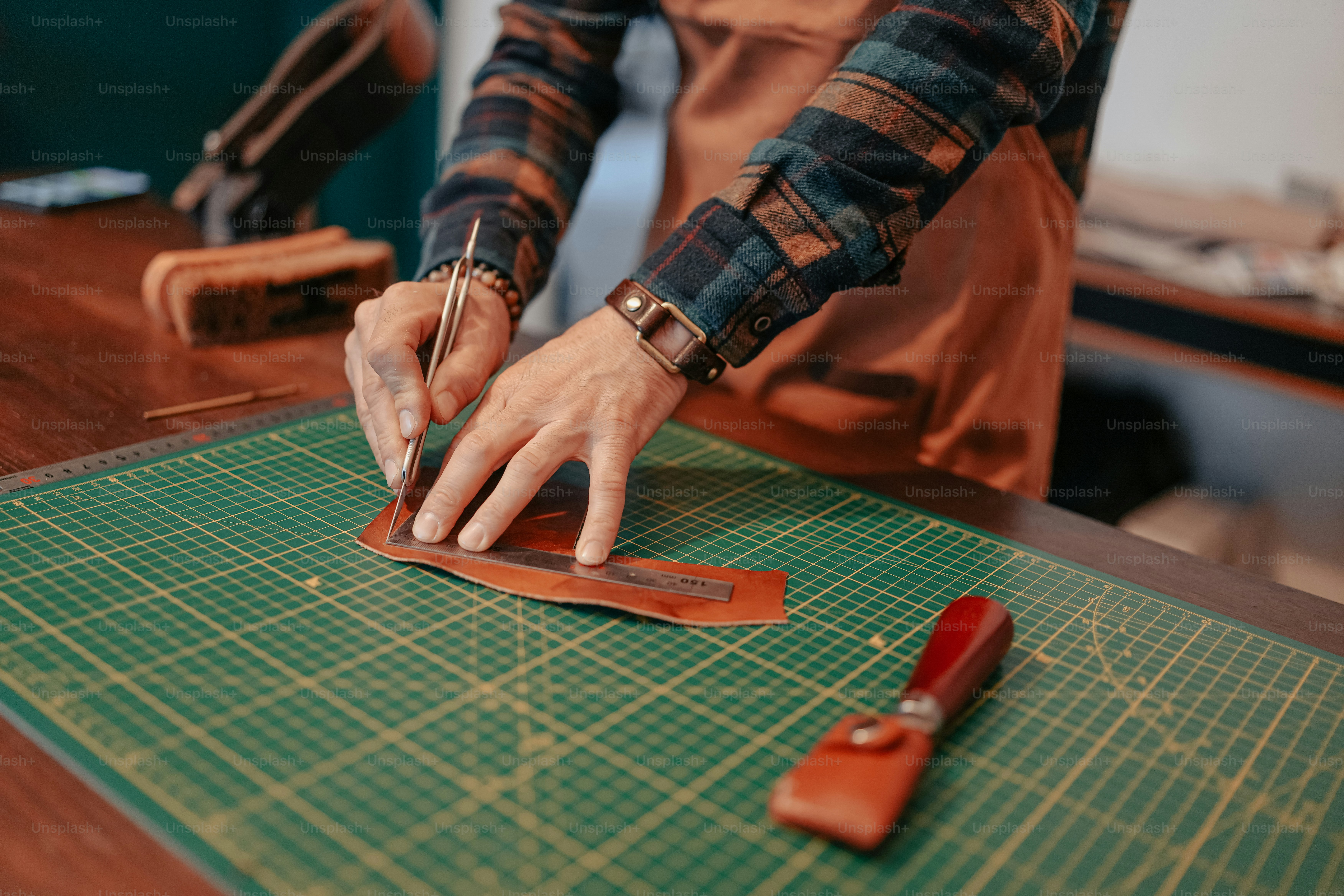 A person holding a pair of scissors in front of a wall of tools photo ...
