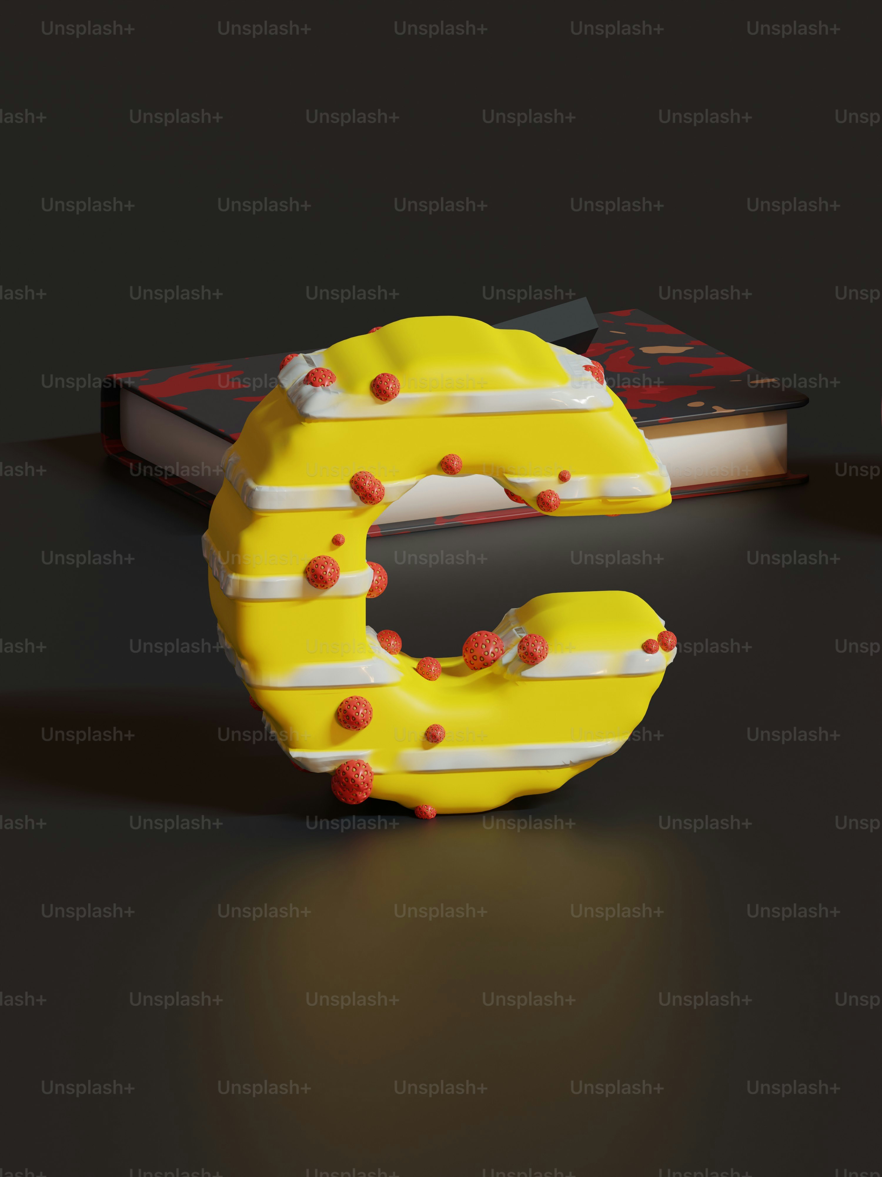 A cake shaped like the letter c on a table photo – Background Image on ...
