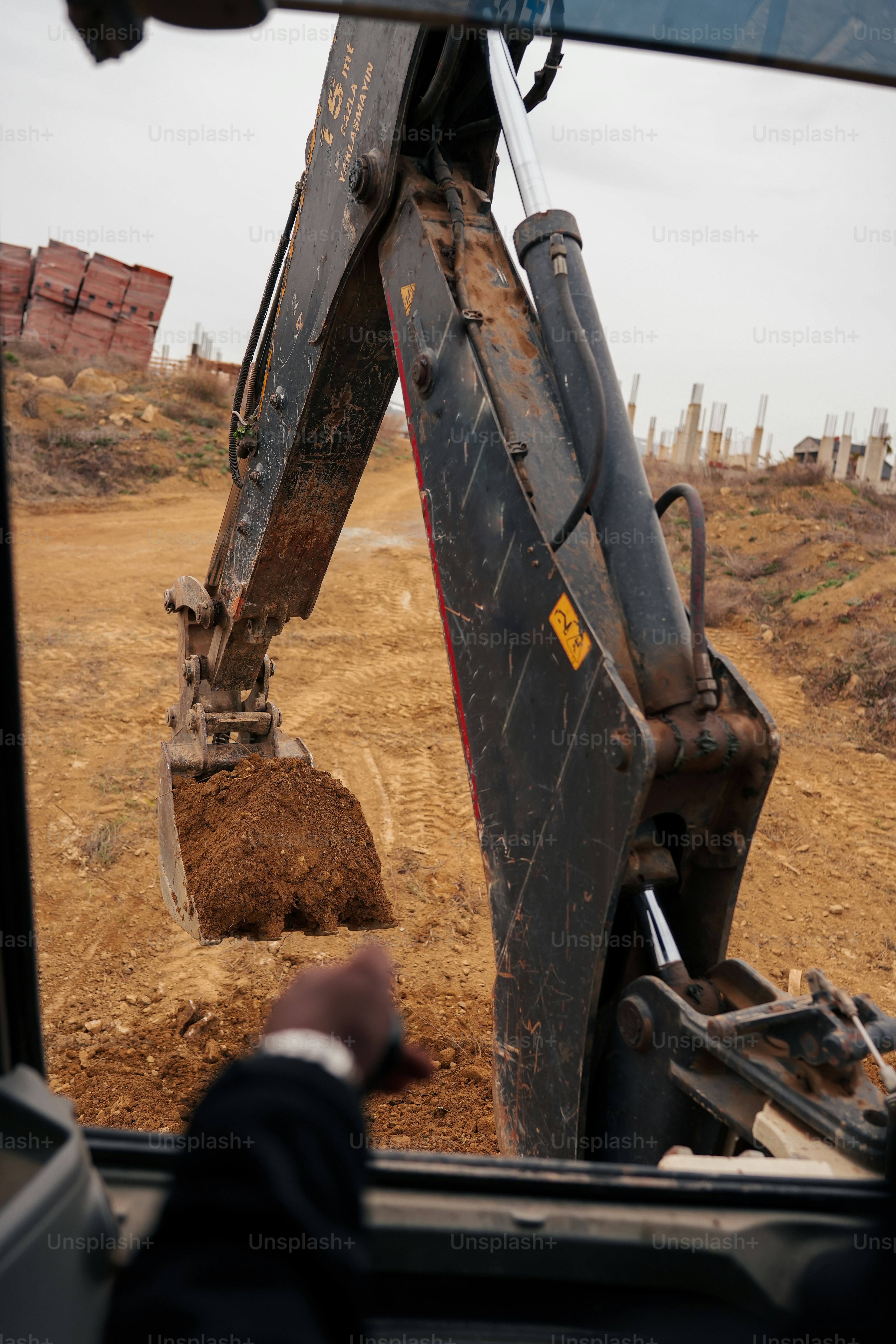 A large machine digging dirt in a field photo – Loader Image on Unsplash