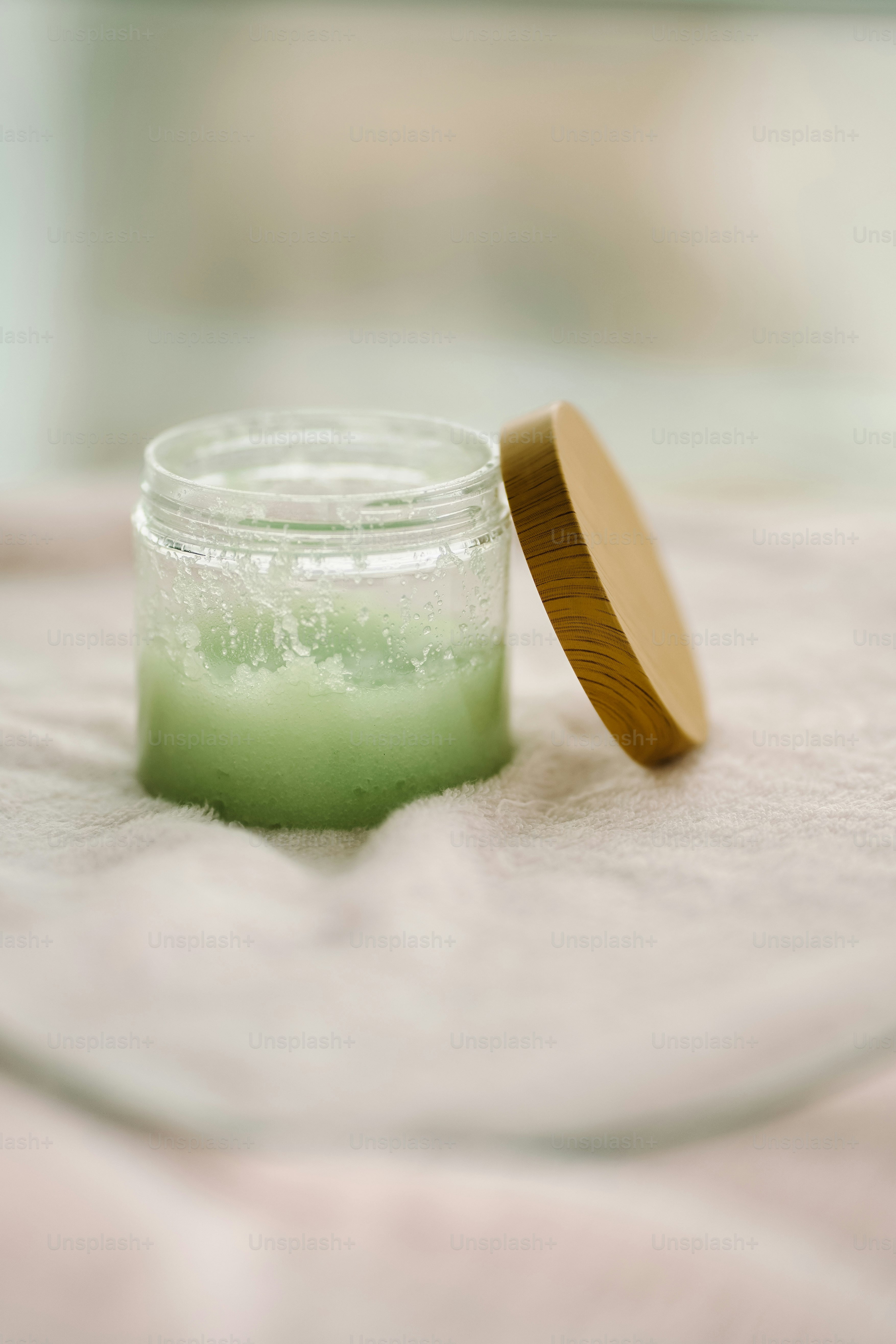 A jar of green liquid with a wooden lid photo – Scrub Image on Unsplash