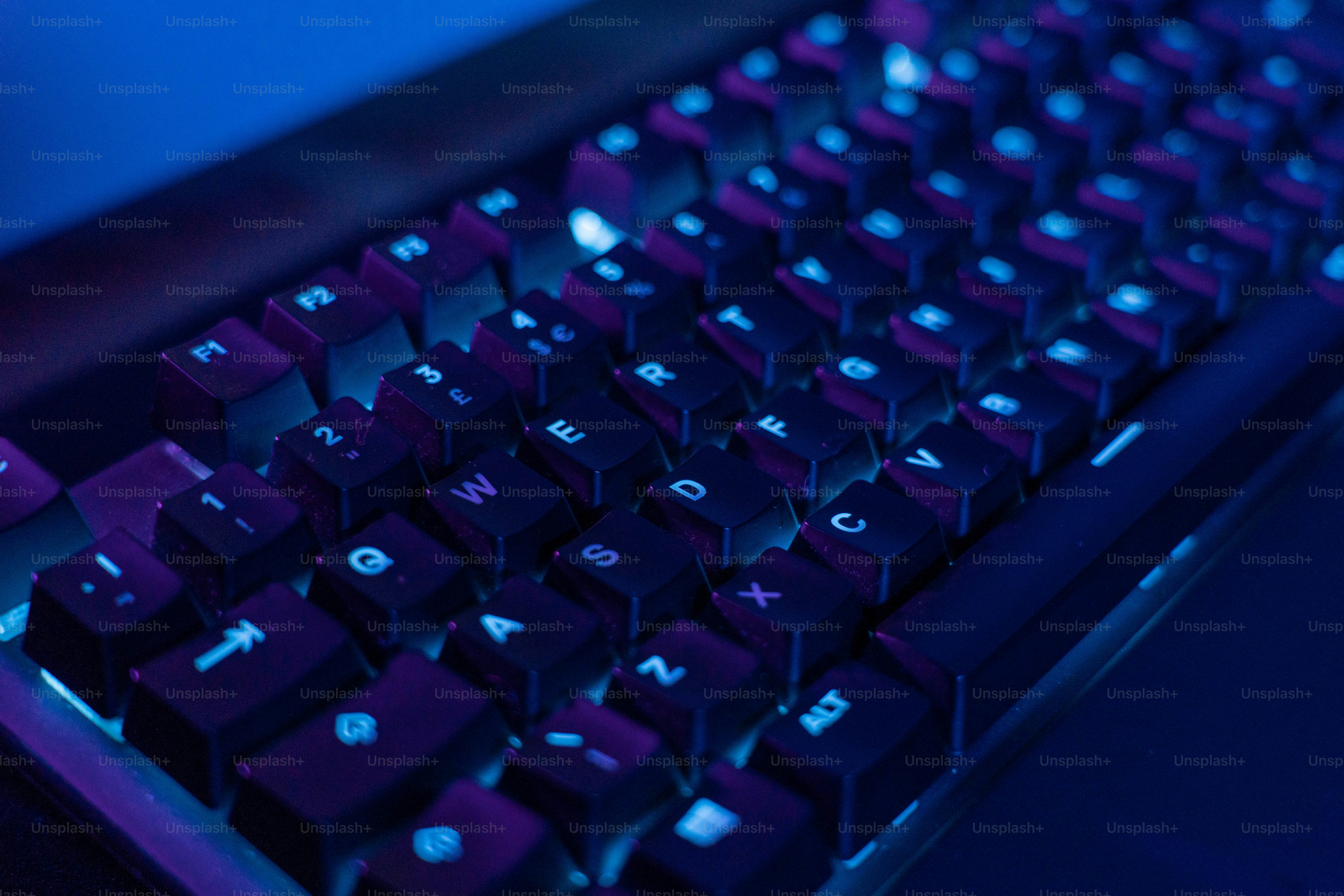A close up of a keyboard with a blue background photo – Gaming keyboard ...