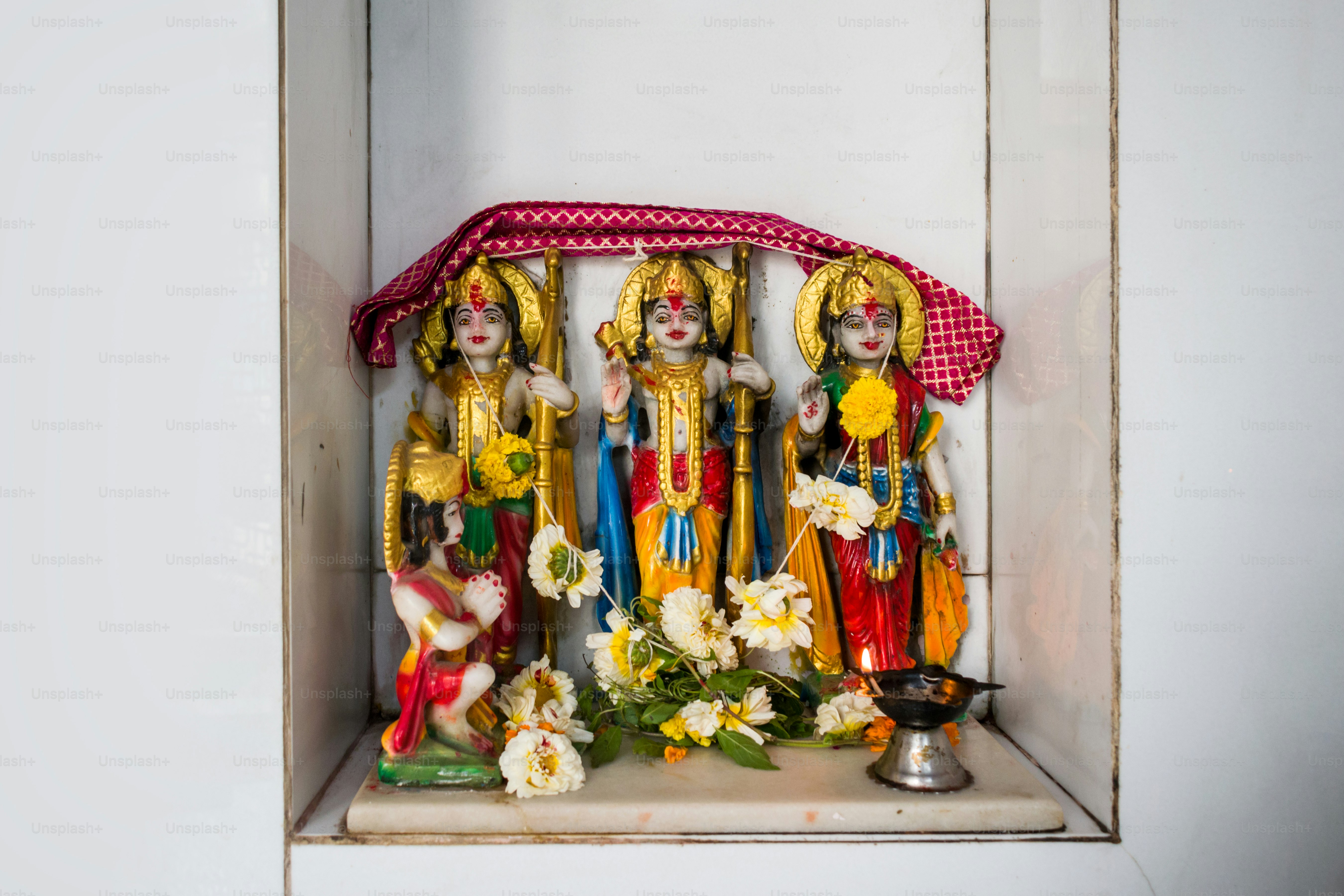 A group of statues of hindu deities in a niche photo – Shrine Image on ...