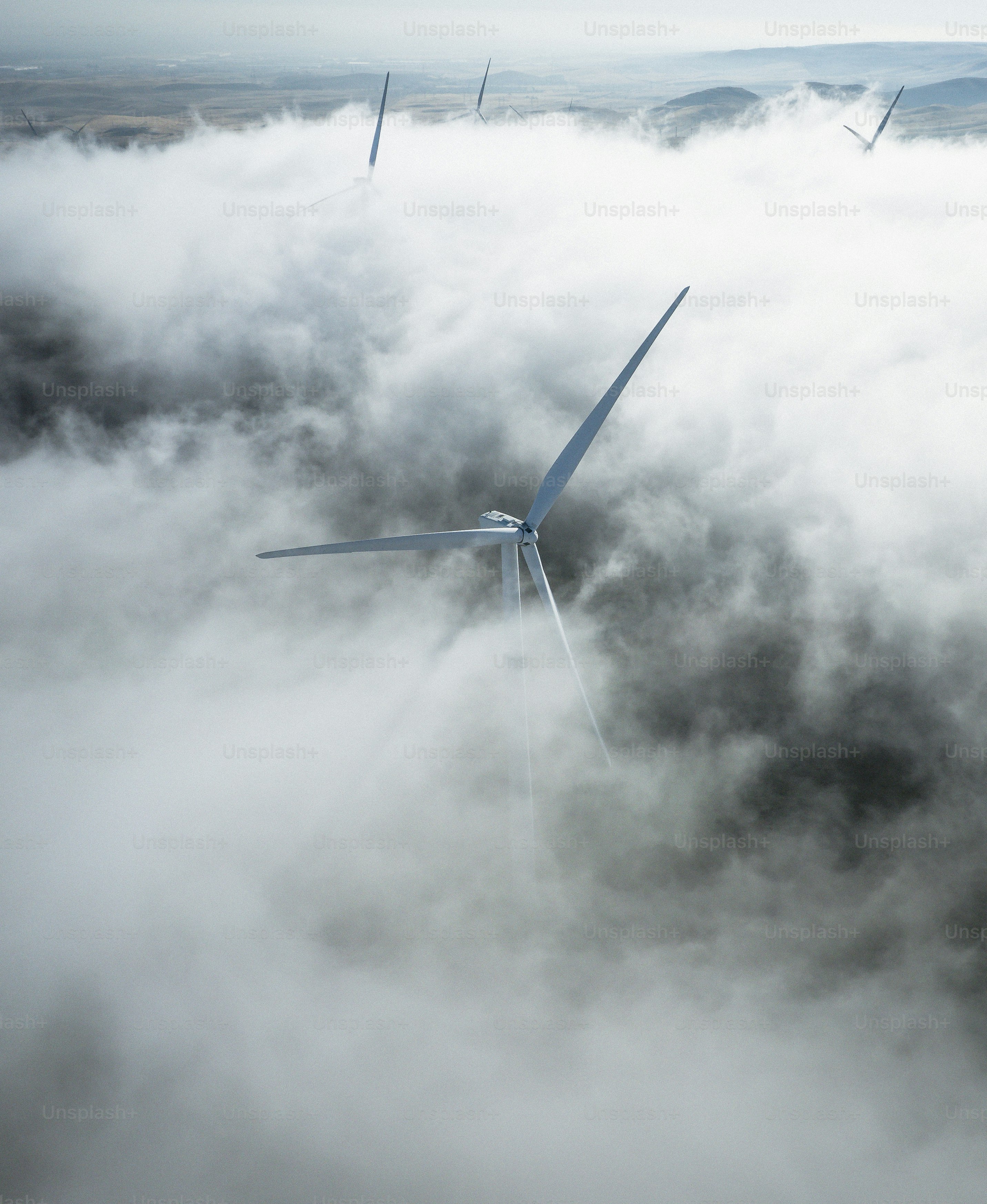 An aerial view of a wind farm with many windmills photo – Electricity ...
