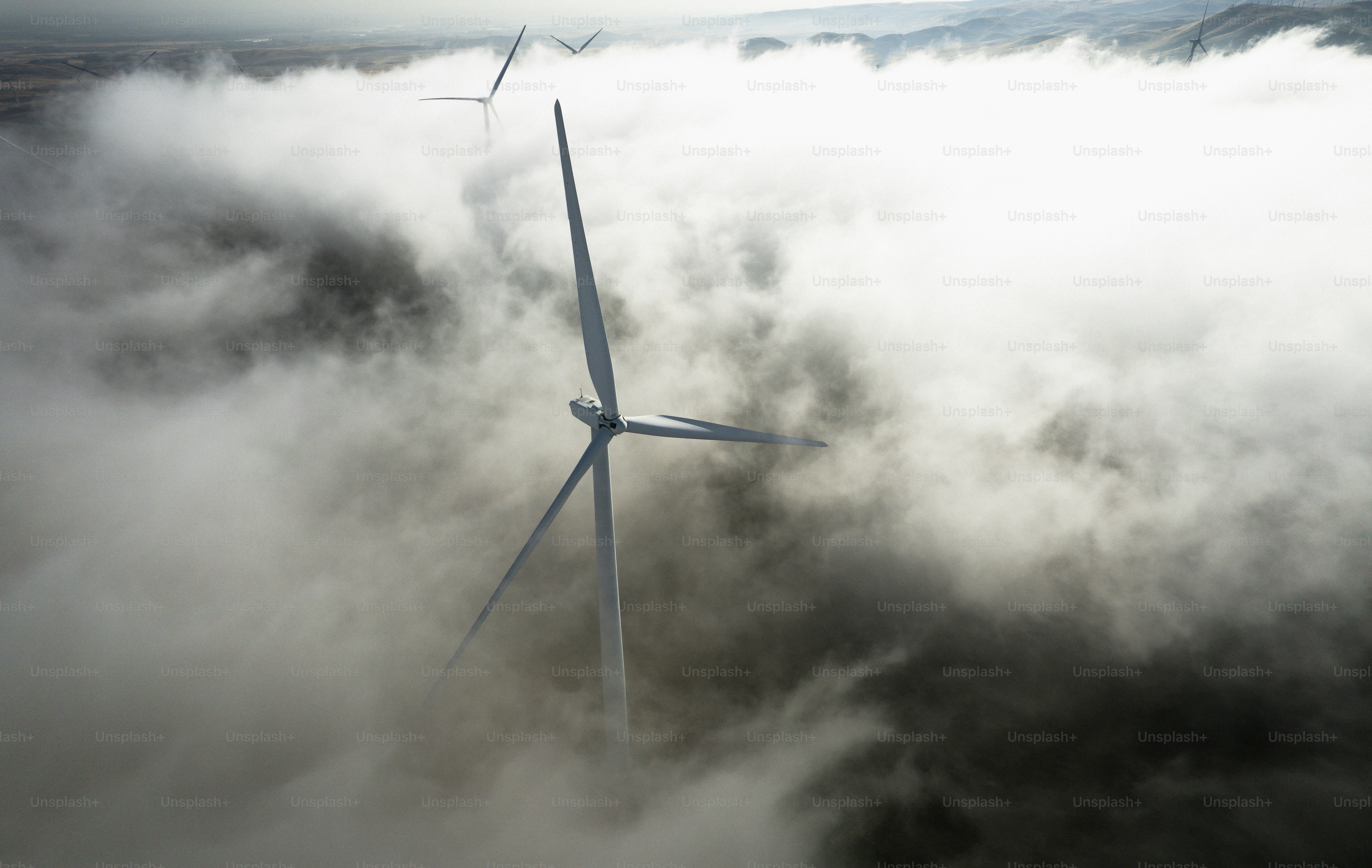 A wind turbine in the middle of a foggy field photo – Eolic Image on ...