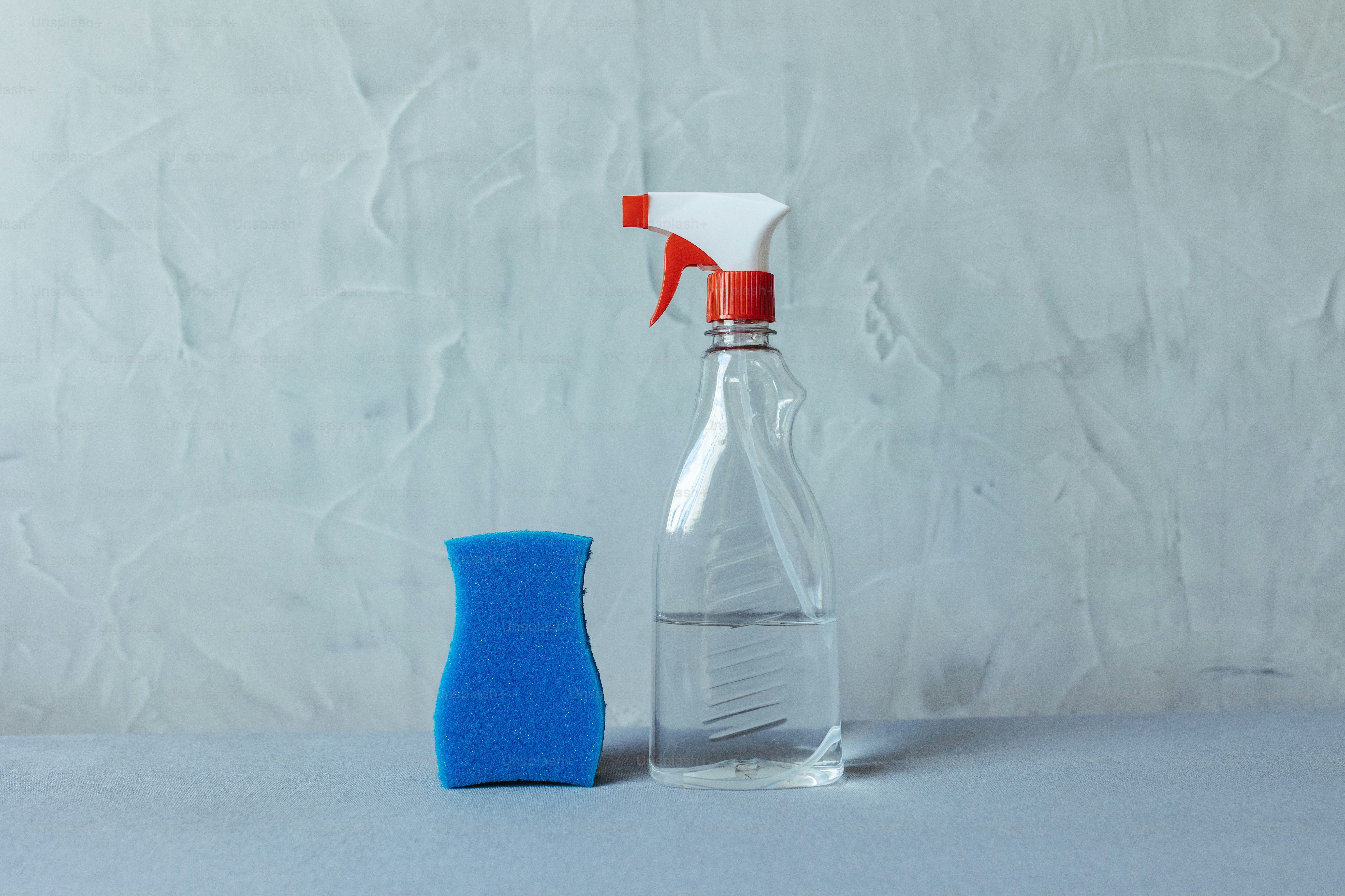 A bottle of cleaner next to a blue sponge photo – Clean Image on Unsplash