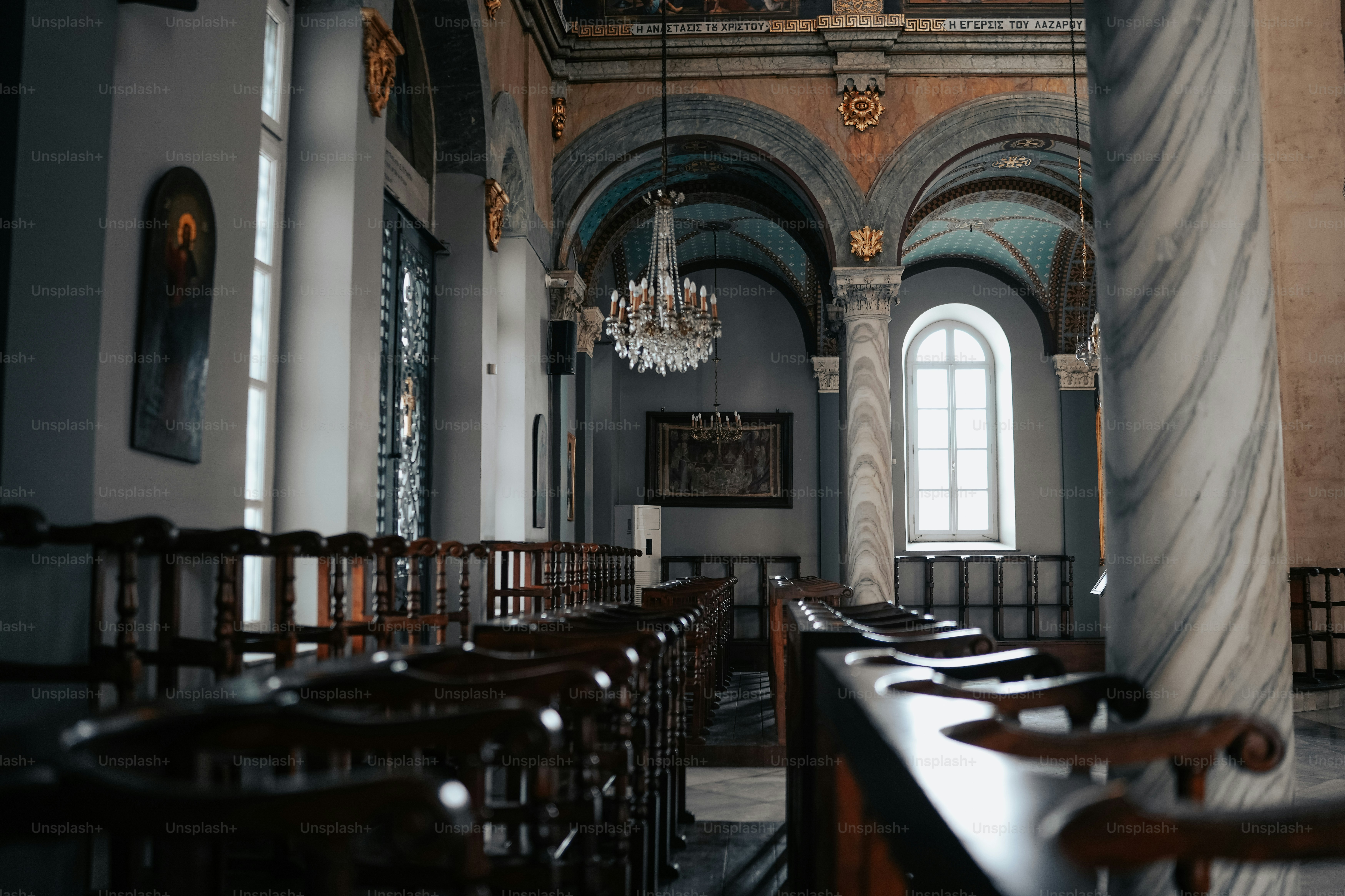 A church with pews and a chandelier hanging from the ceiling photo ...