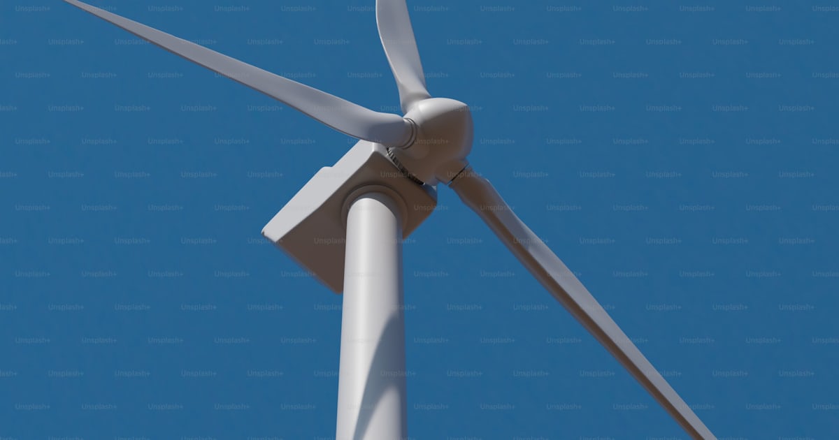 Eine Weiße Windkraftanlage Vor Blauem Himmel Foto Bild Zum Thema