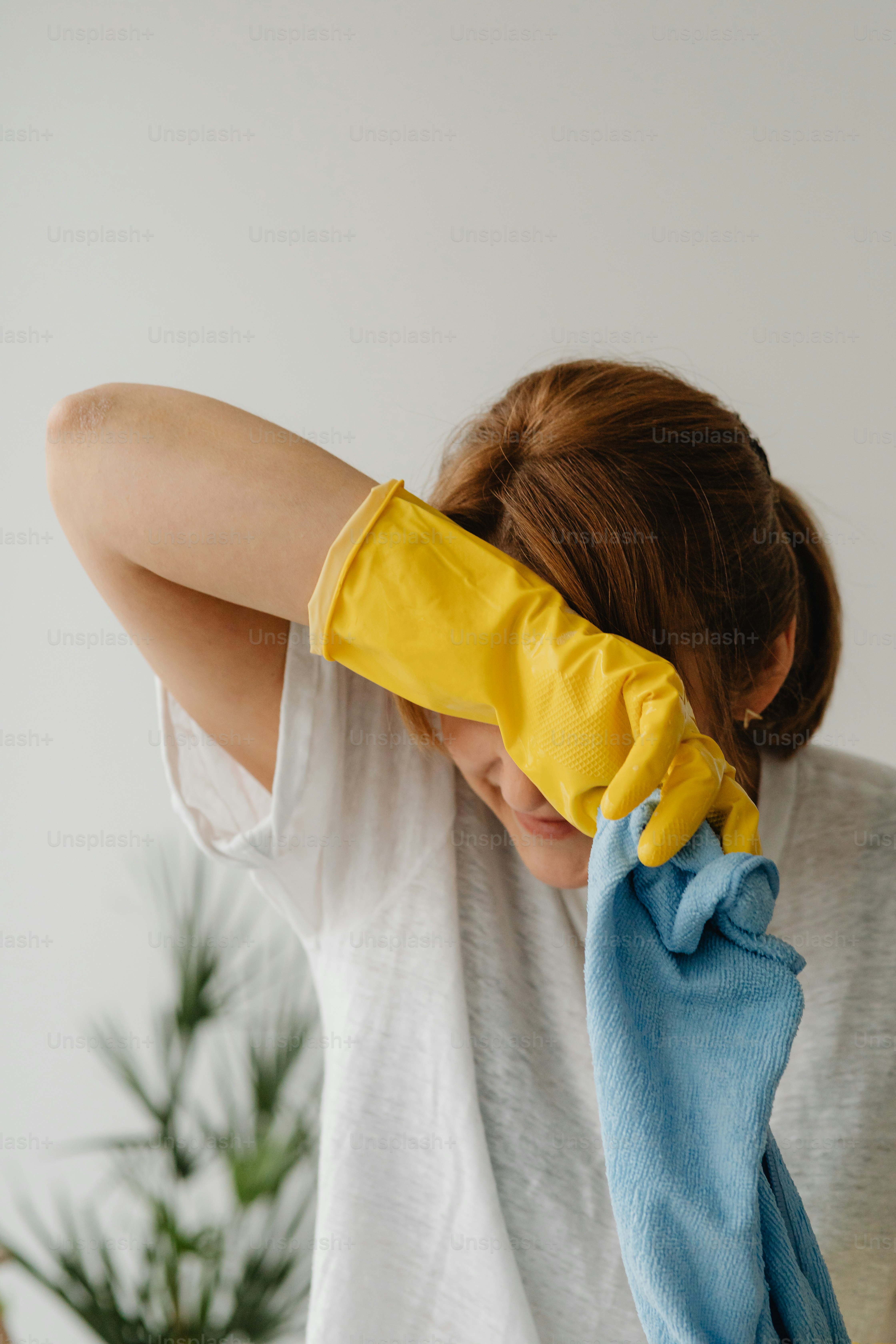 A person's hand wearing yellow rubber gloves and cleaning cloth photo ...