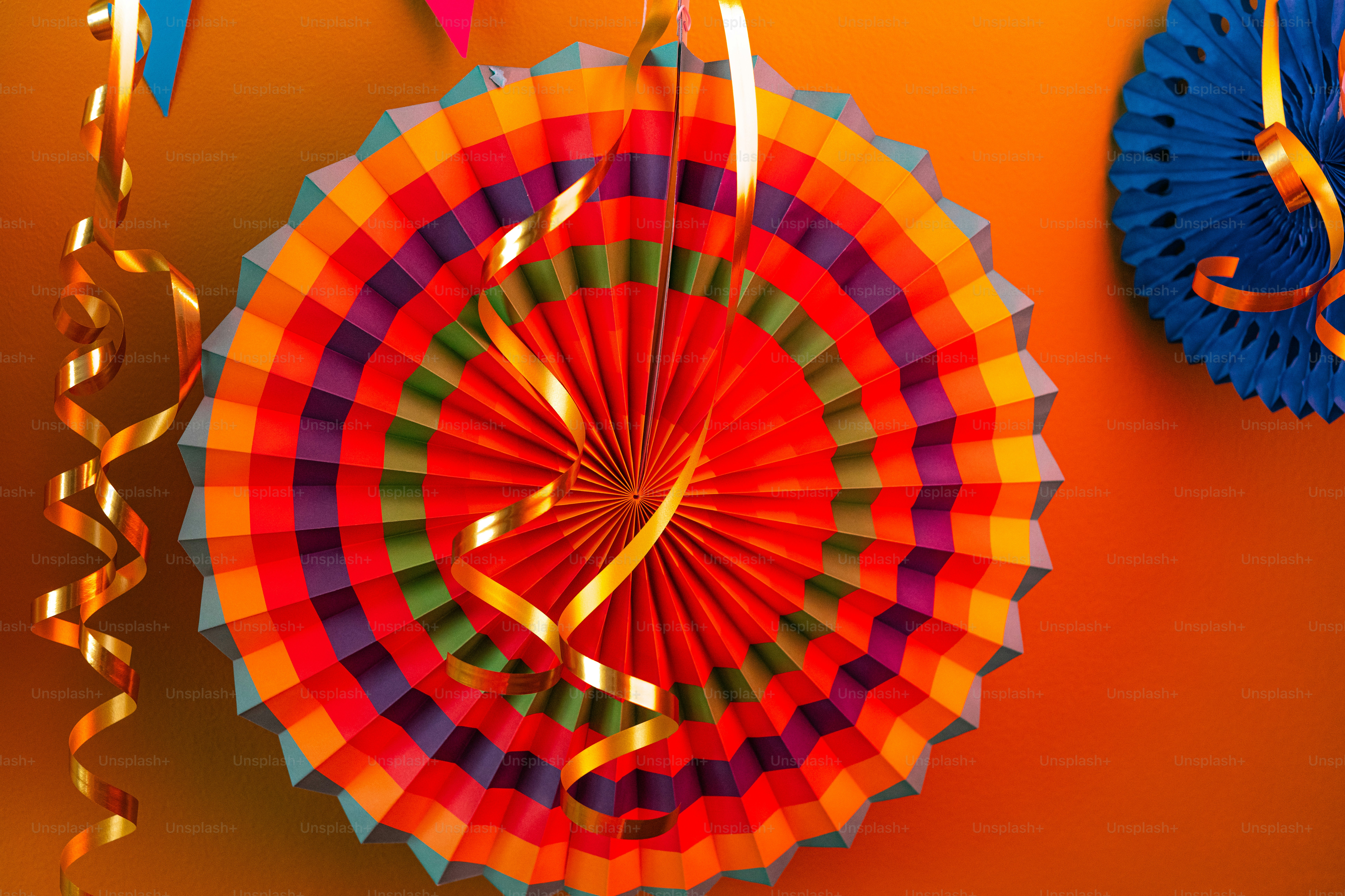 A colorful paper fan sitting on top of a table photo – Food ...