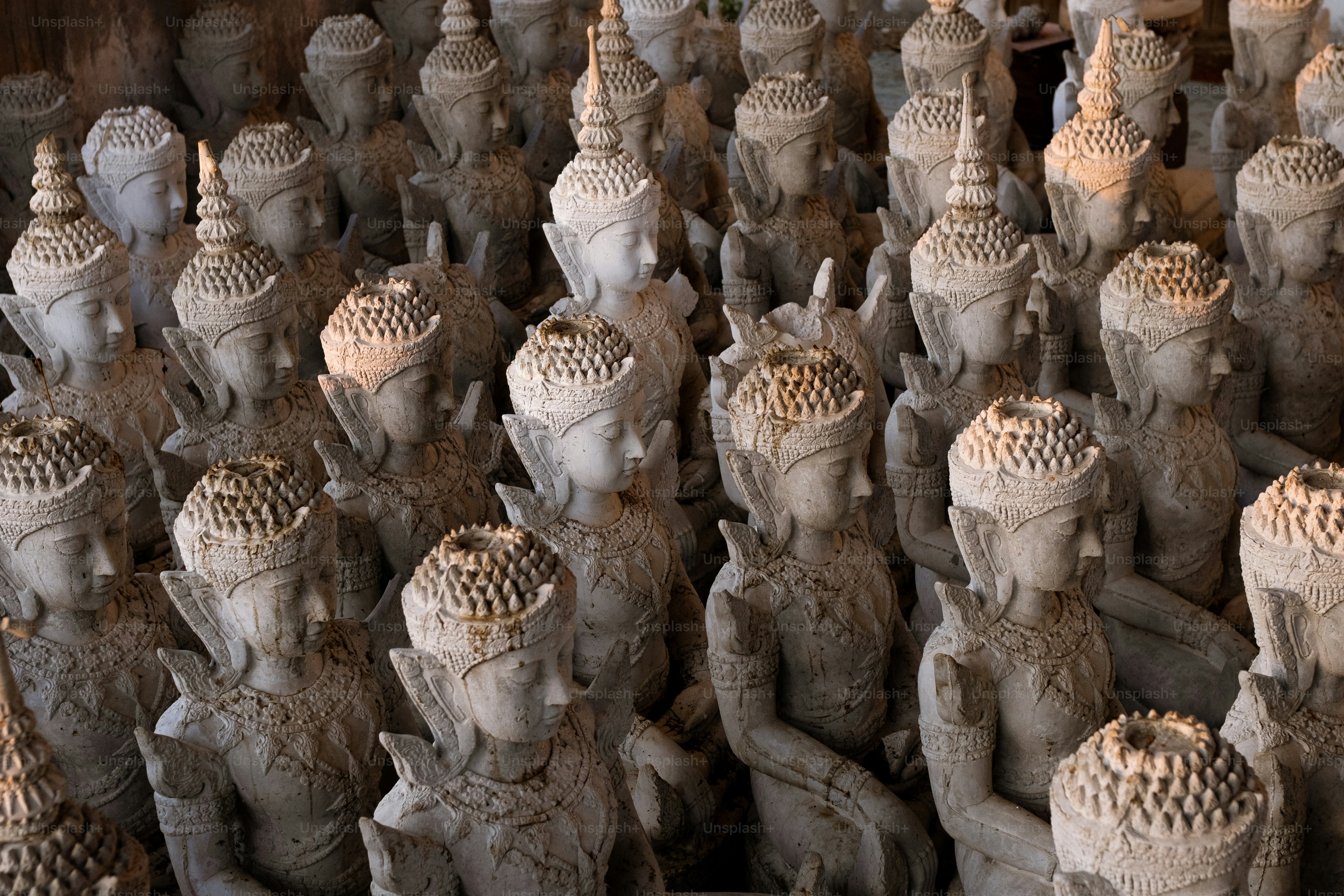 A group of statues sitting next to each other photo – Sculptures Image ...