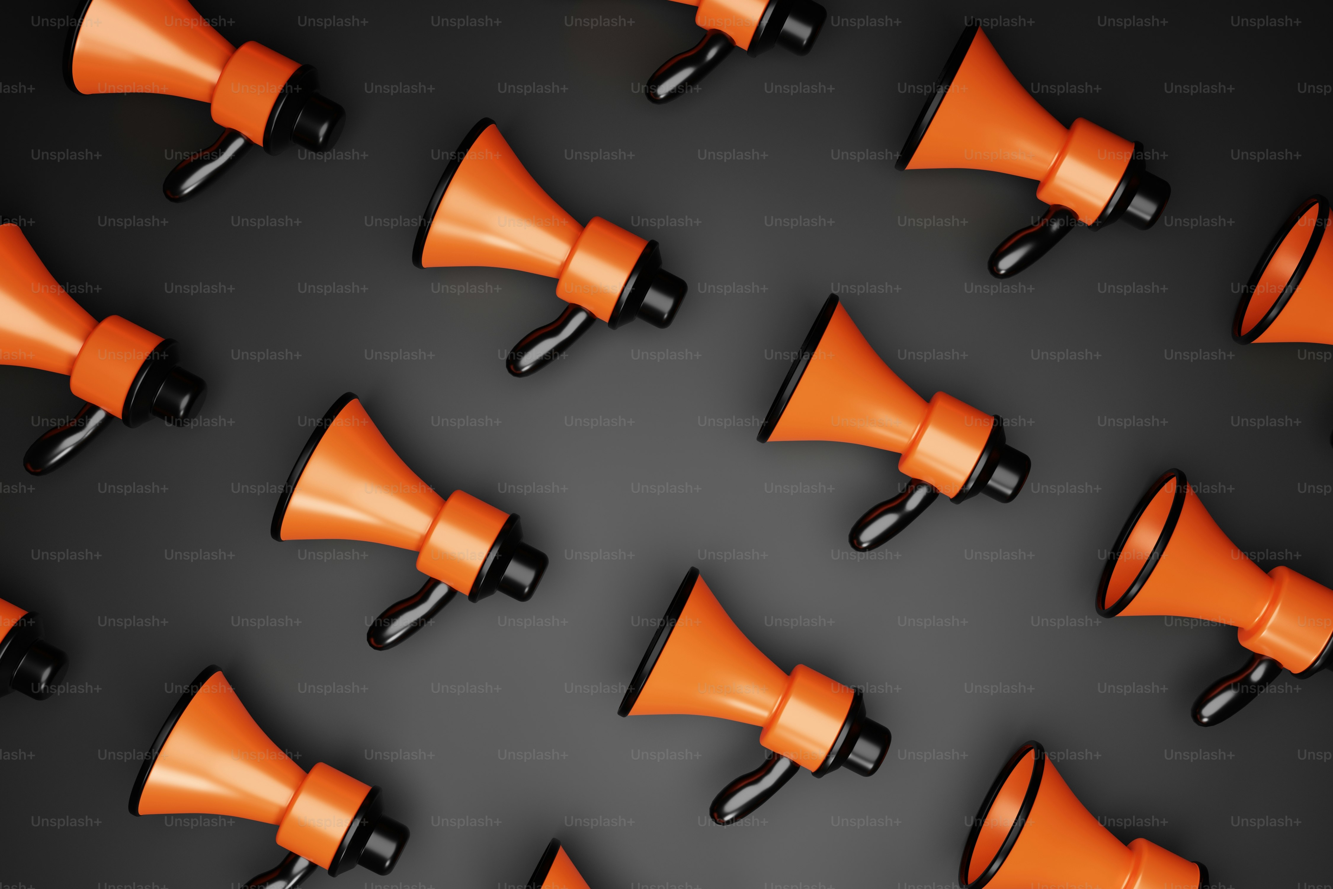 A group of orange and black megaphones on a black surface photo ...