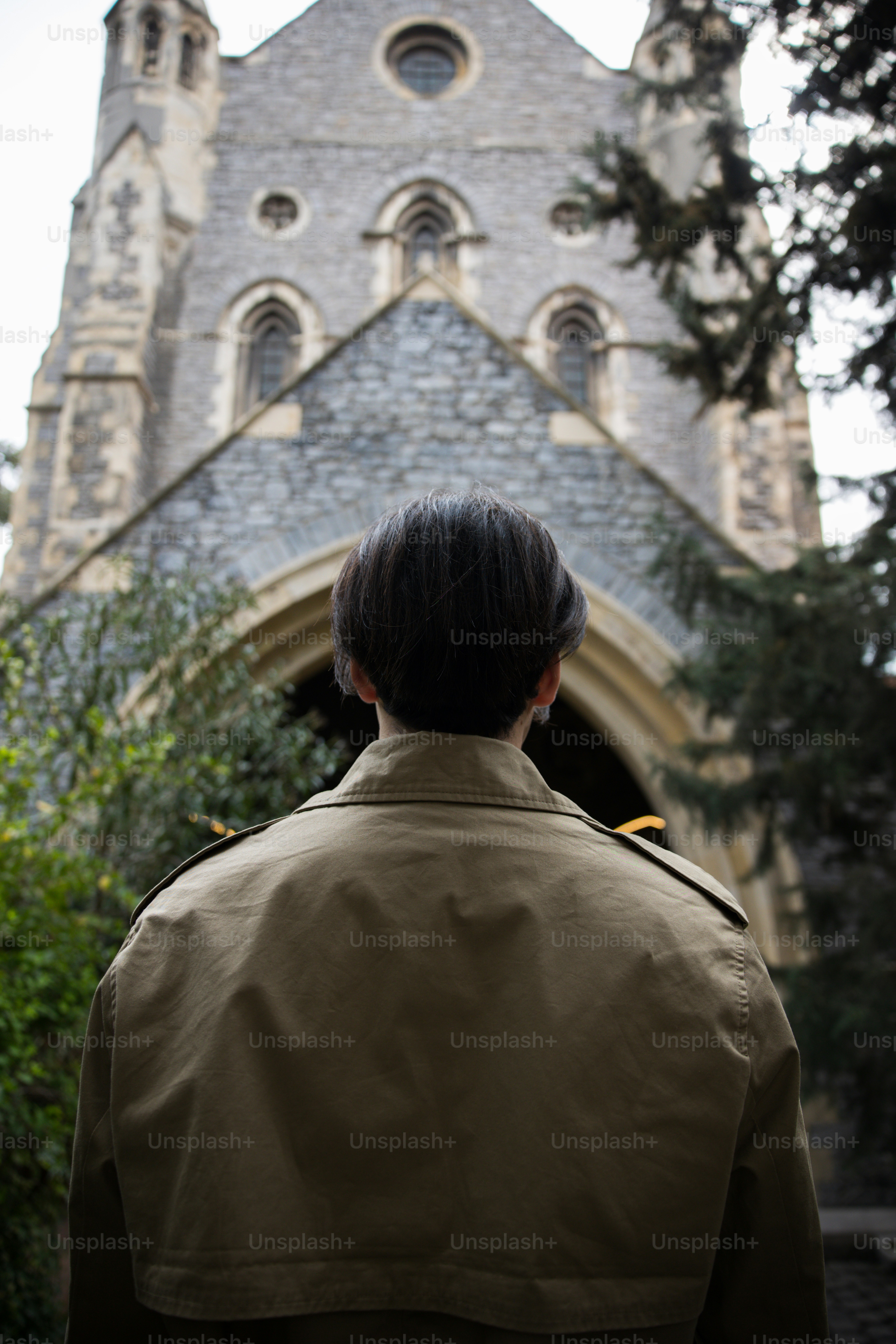A man standing in front of a tall building photo – Kırım kilisesi Image ...