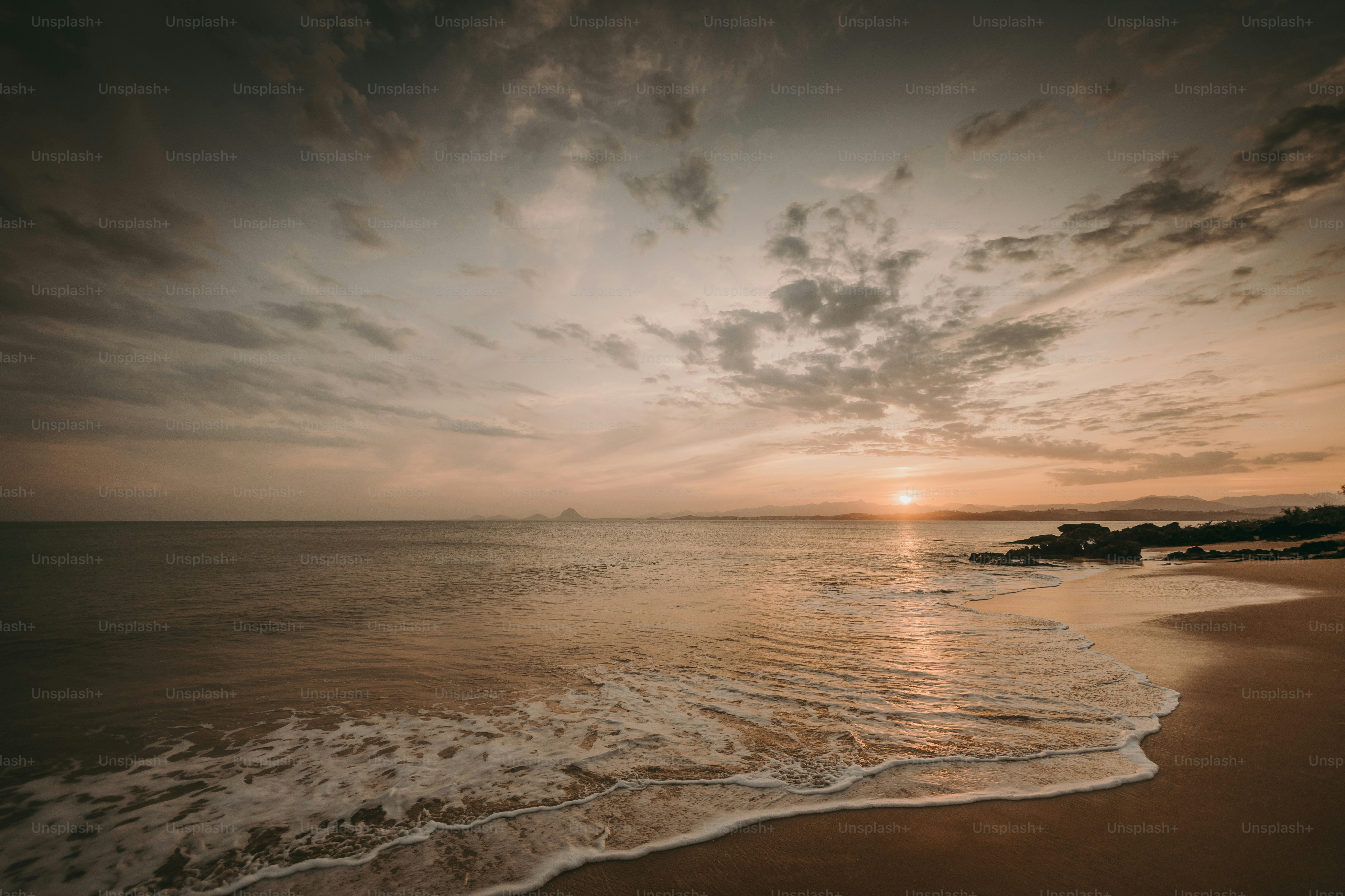 The sun is setting over the water at the beach photo – Sunset beach ...