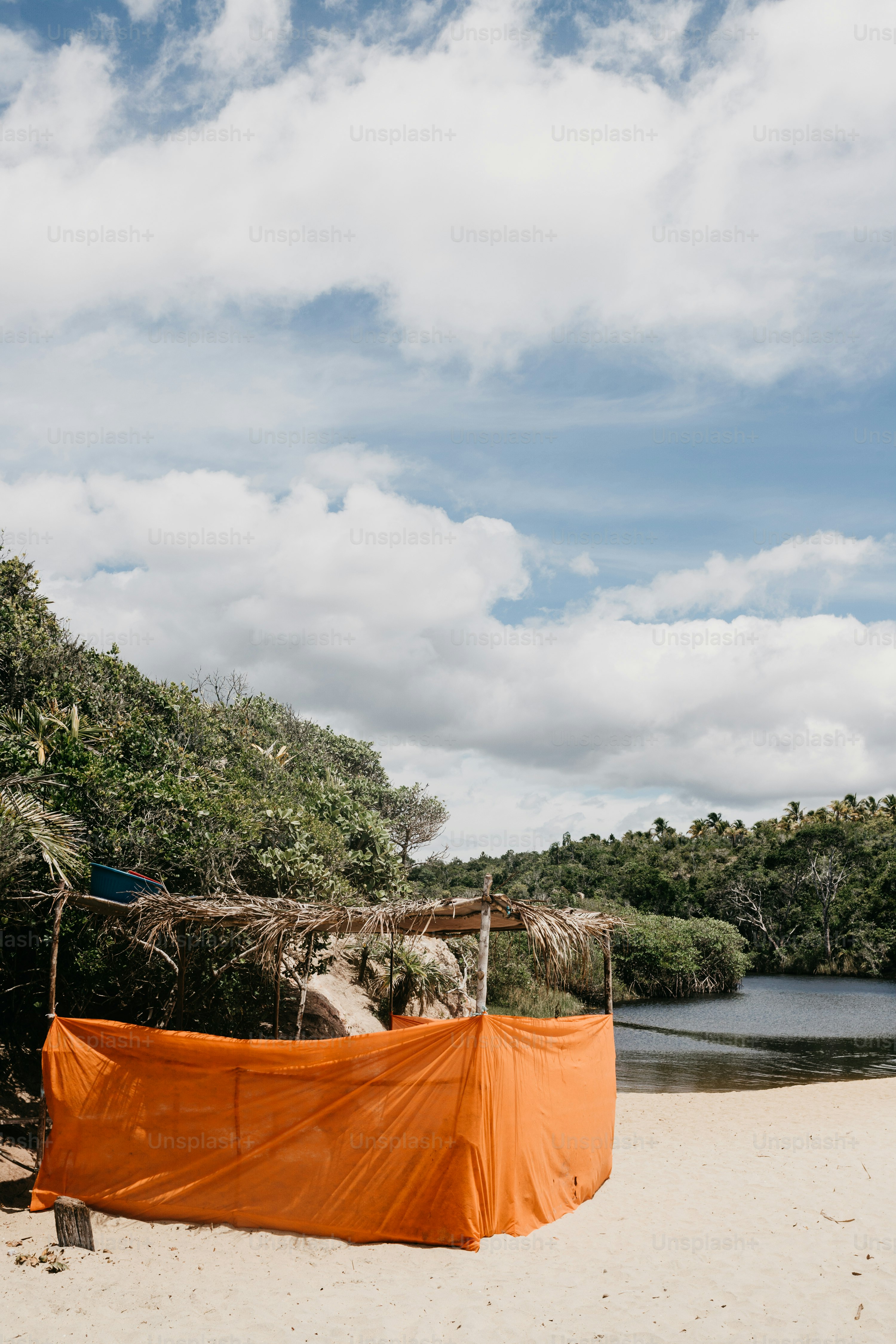 An orange tarp covering a boat on a beach photo – Beach Image on Unsplash