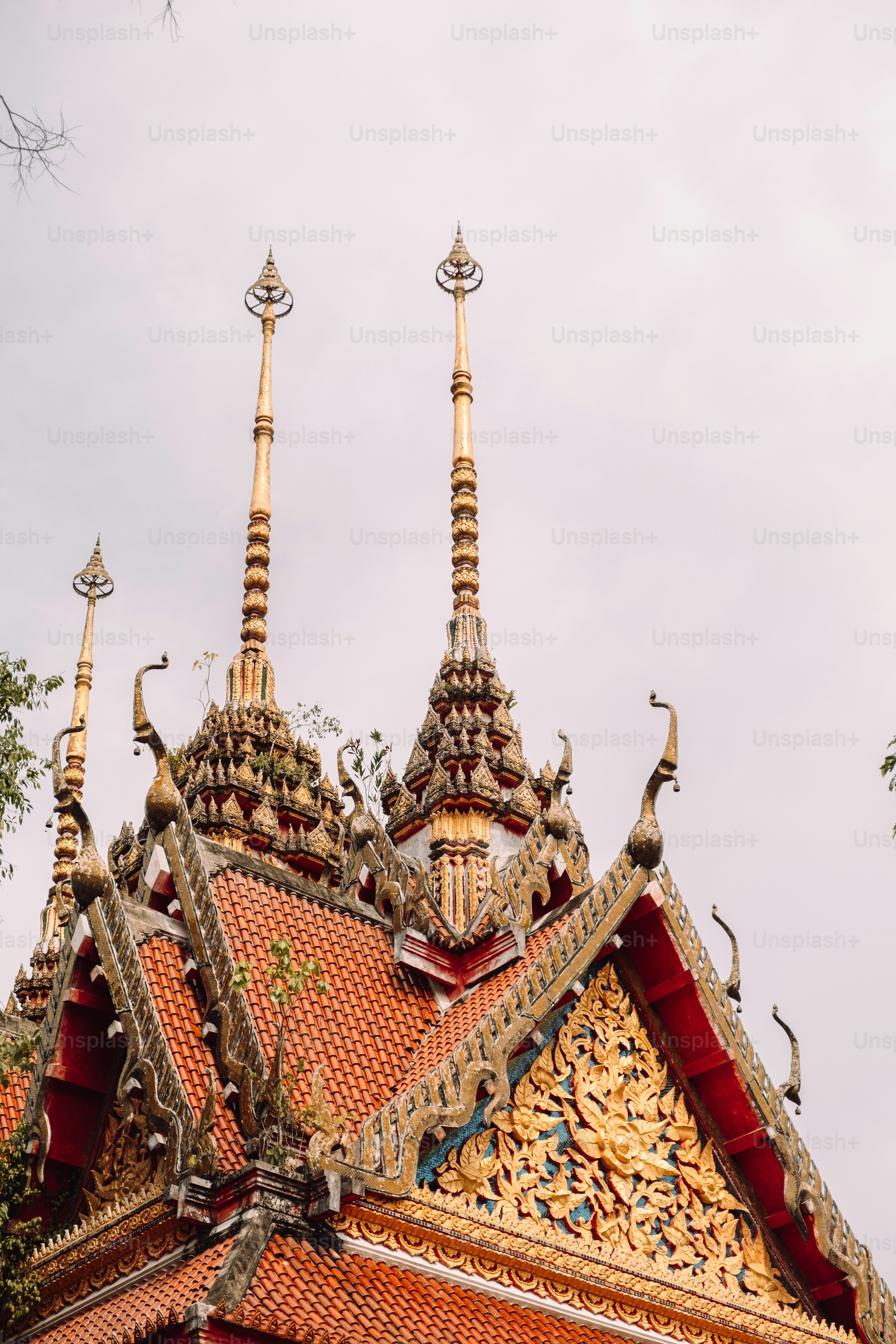 An ornate building with a red roof and gold spires photo – Meditation ...