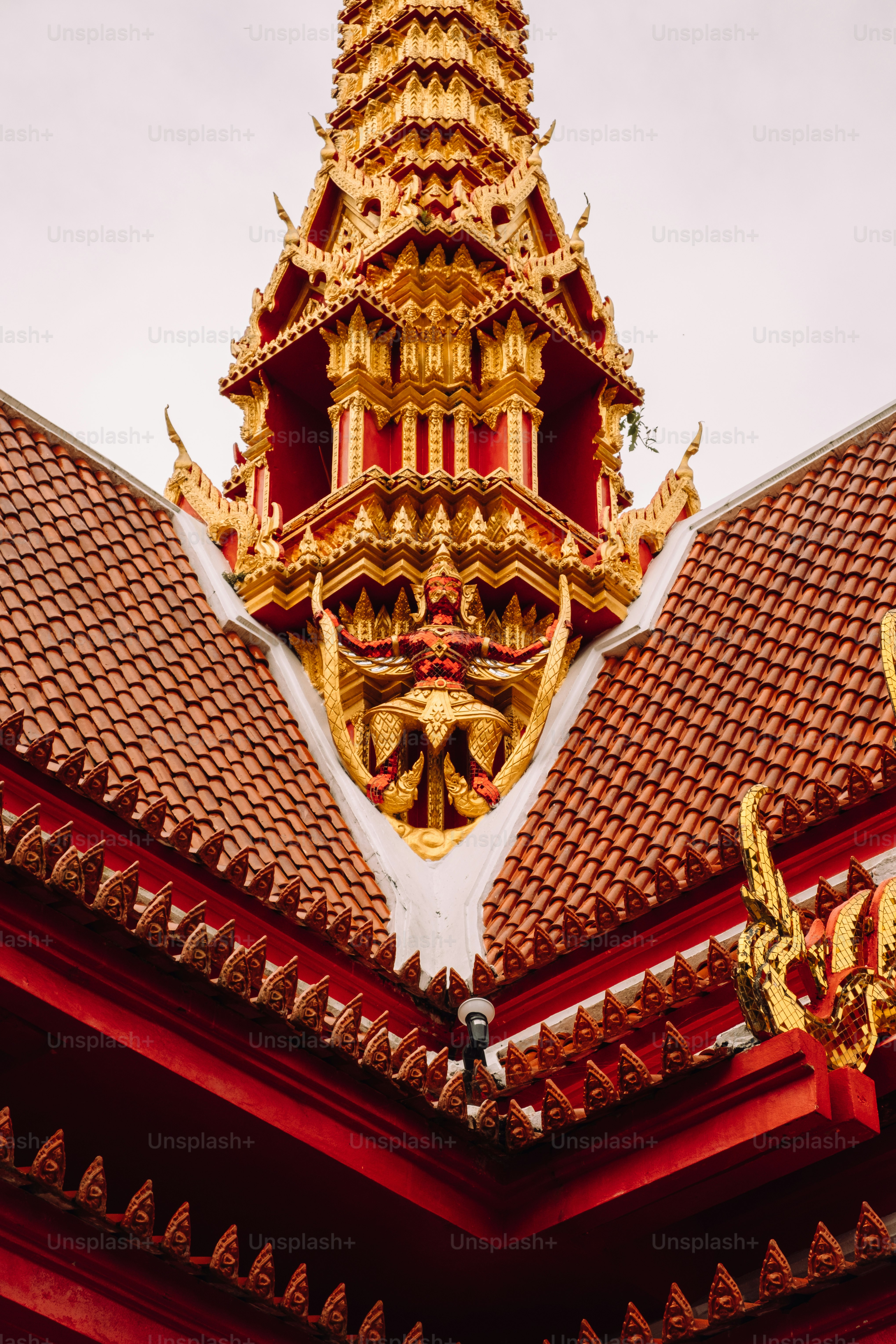 A red and gold building with a tall tower photo – Faith Image on Unsplash