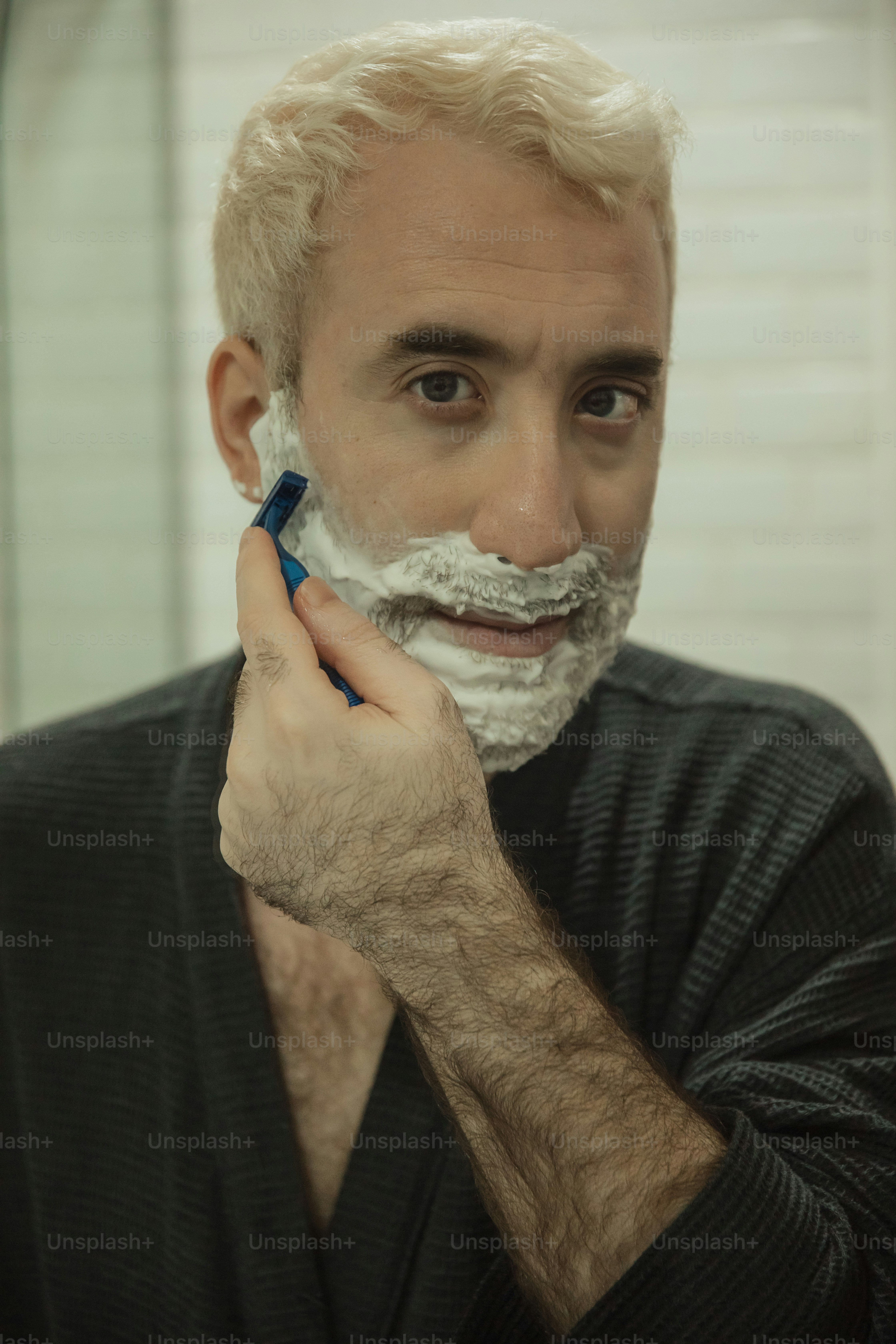 A man shaving his face with a razor photo – Selfcare Image on Unsplash