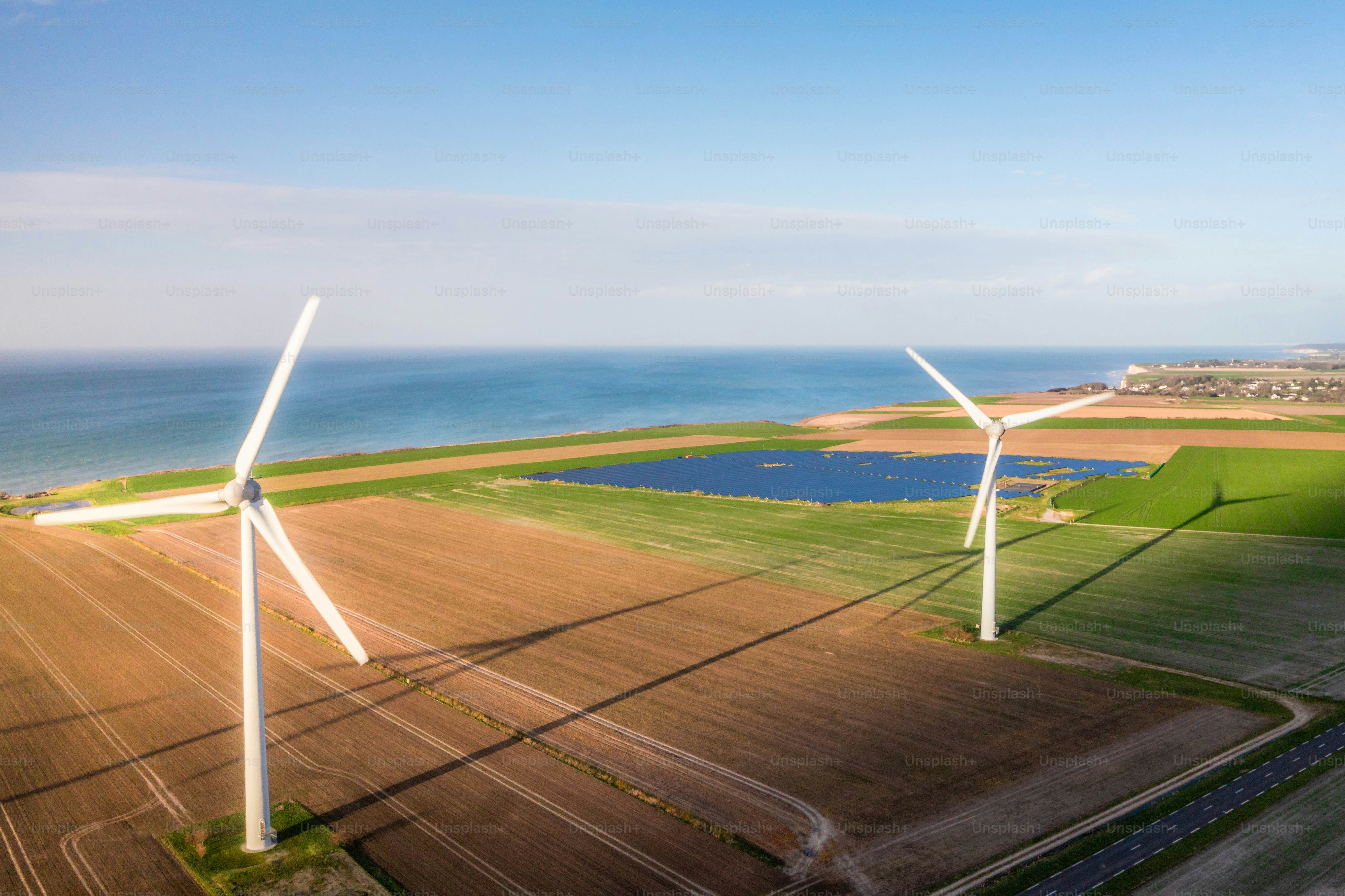 A large field with a bunch of windmills in the background photo ...