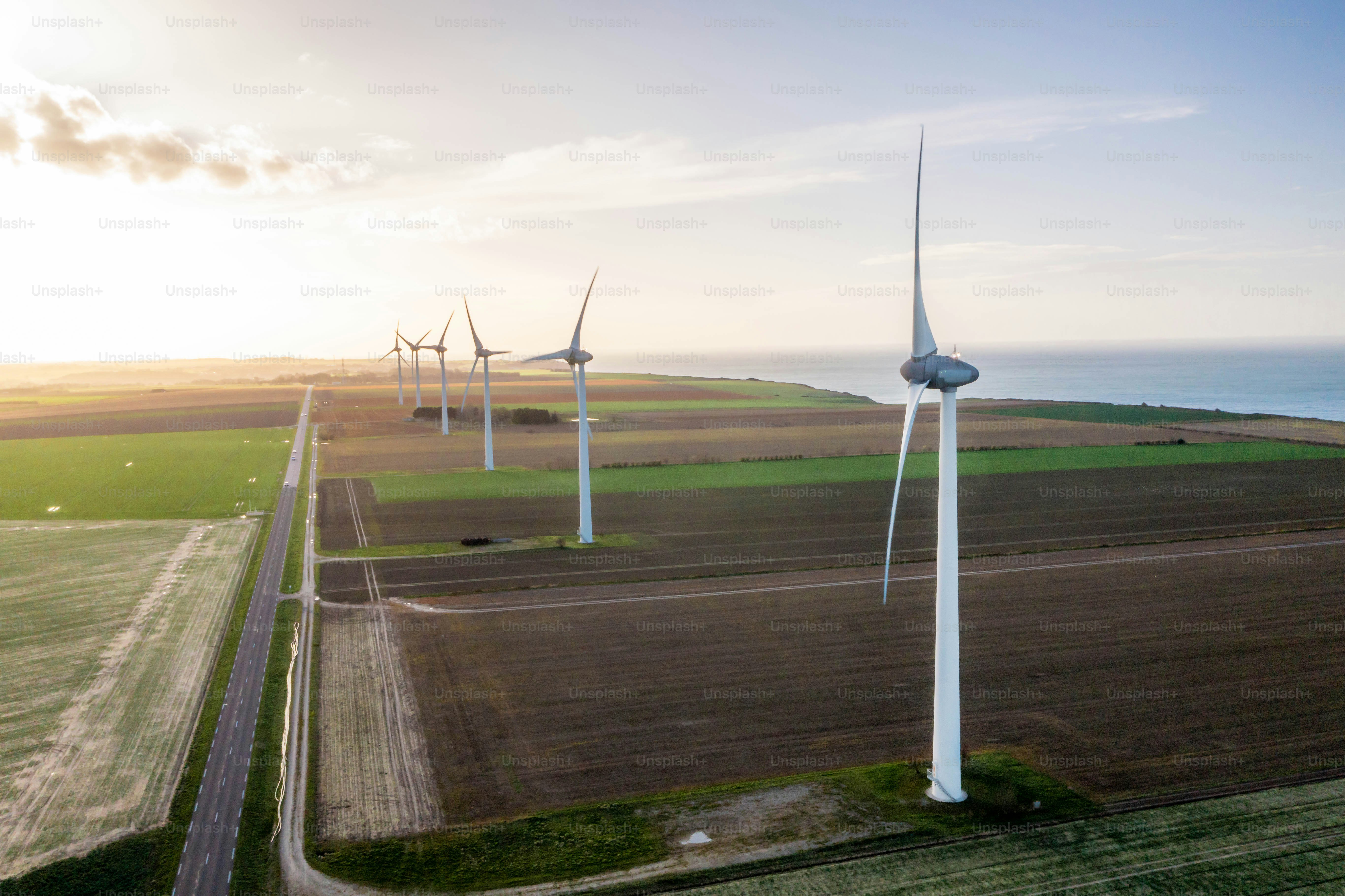 A large field with a bunch of windmills in the background photo ...