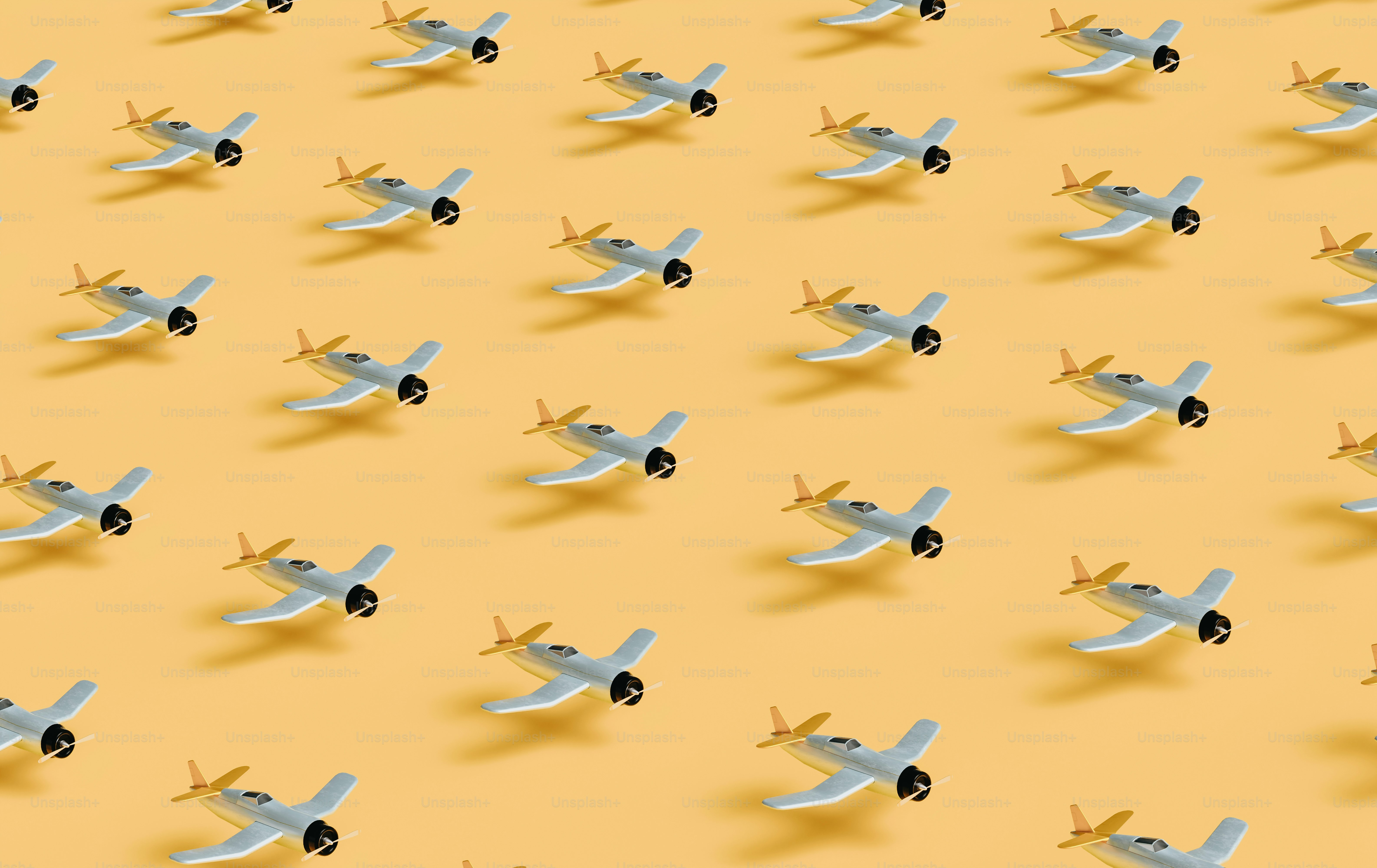 A group of small airplanes flying through a yellow sky photo – Render ...