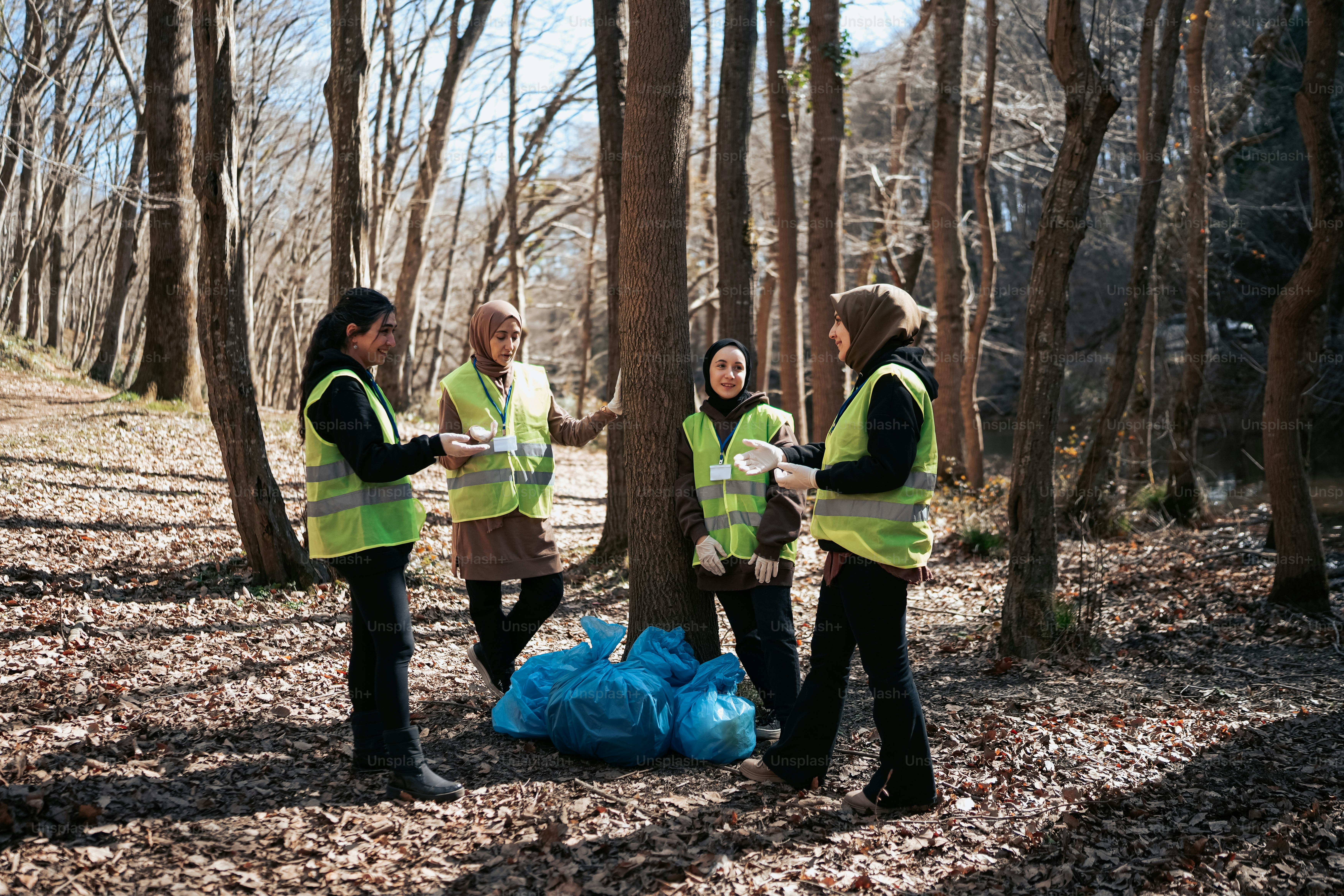 A group of people standing around a forest photo – Volunteering Image ...