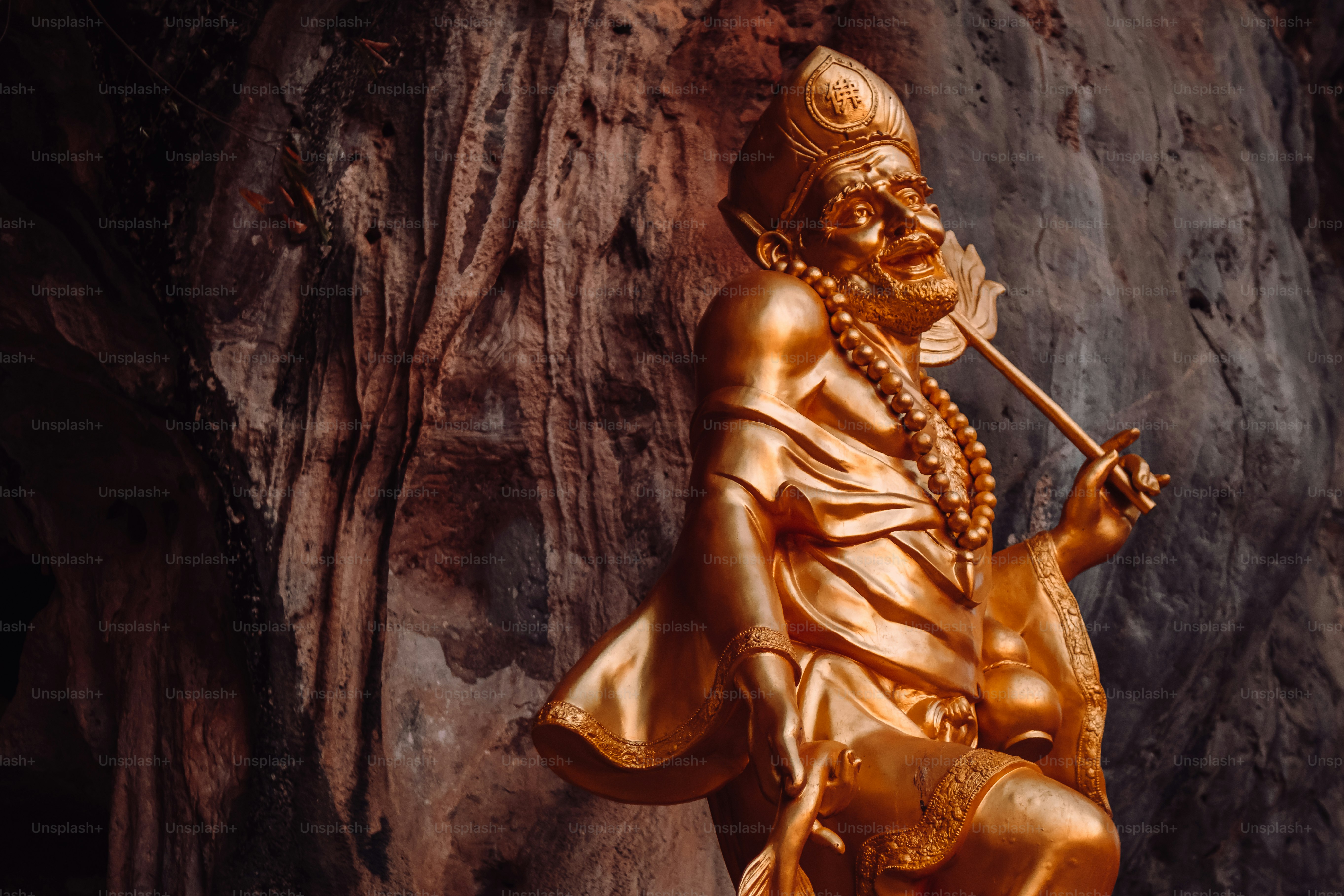 A golden statue of a man with a cane photo – Gods Image on Unsplash