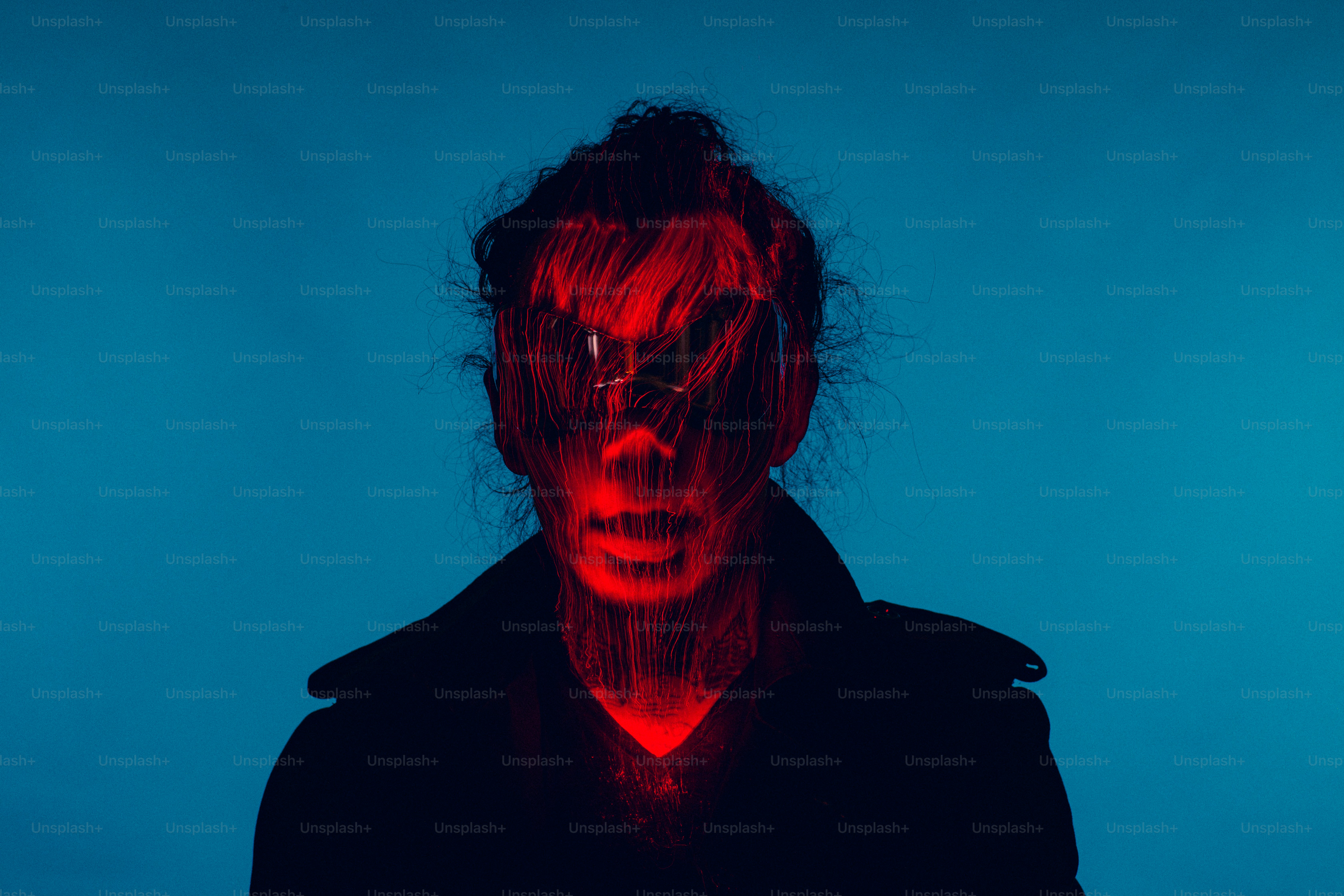A man with a red light on his face photo – Abstract Image on Unsplash