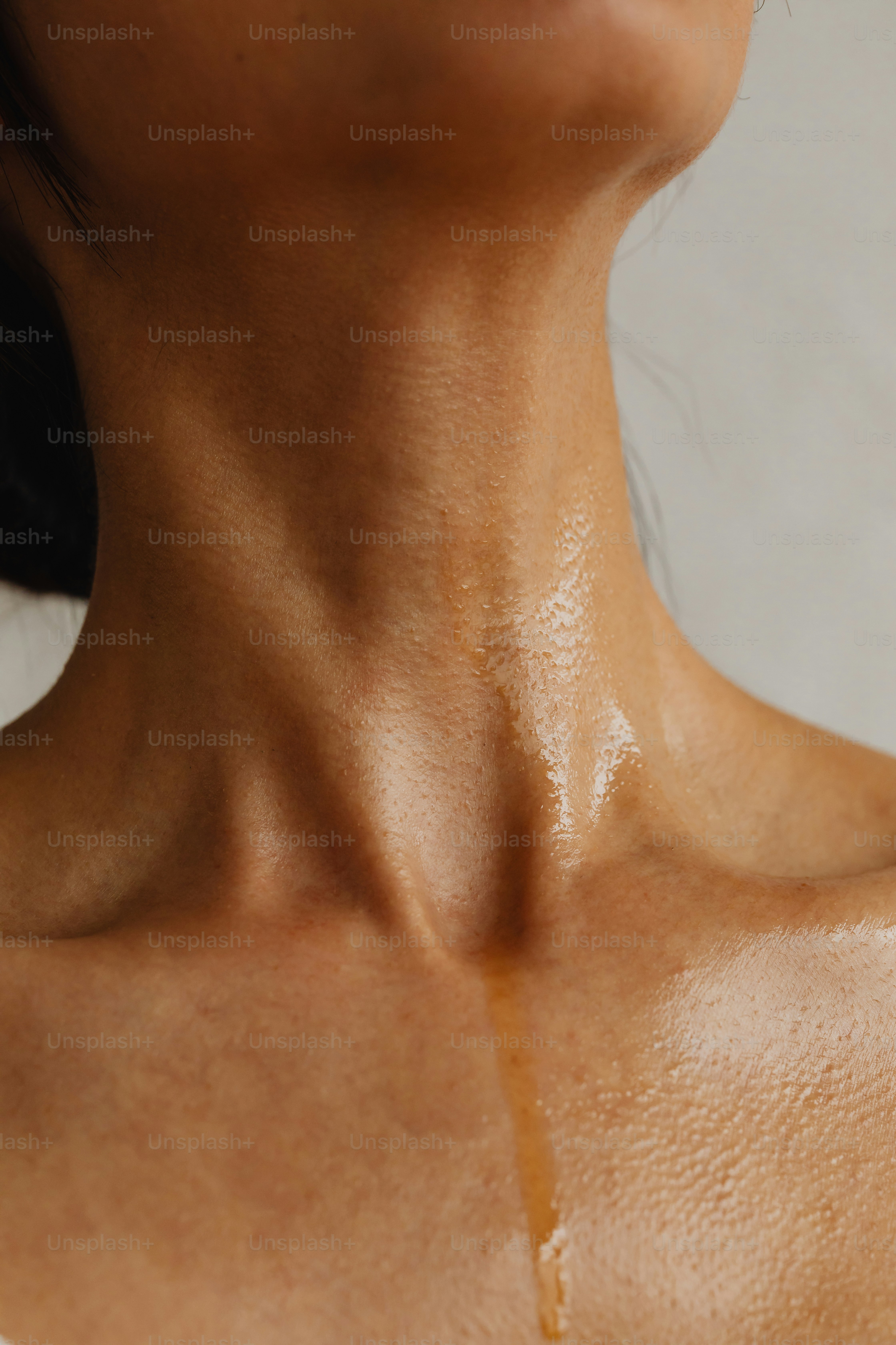 A close up of a woman's neck with a lot of oil on it photo – Skincare ...