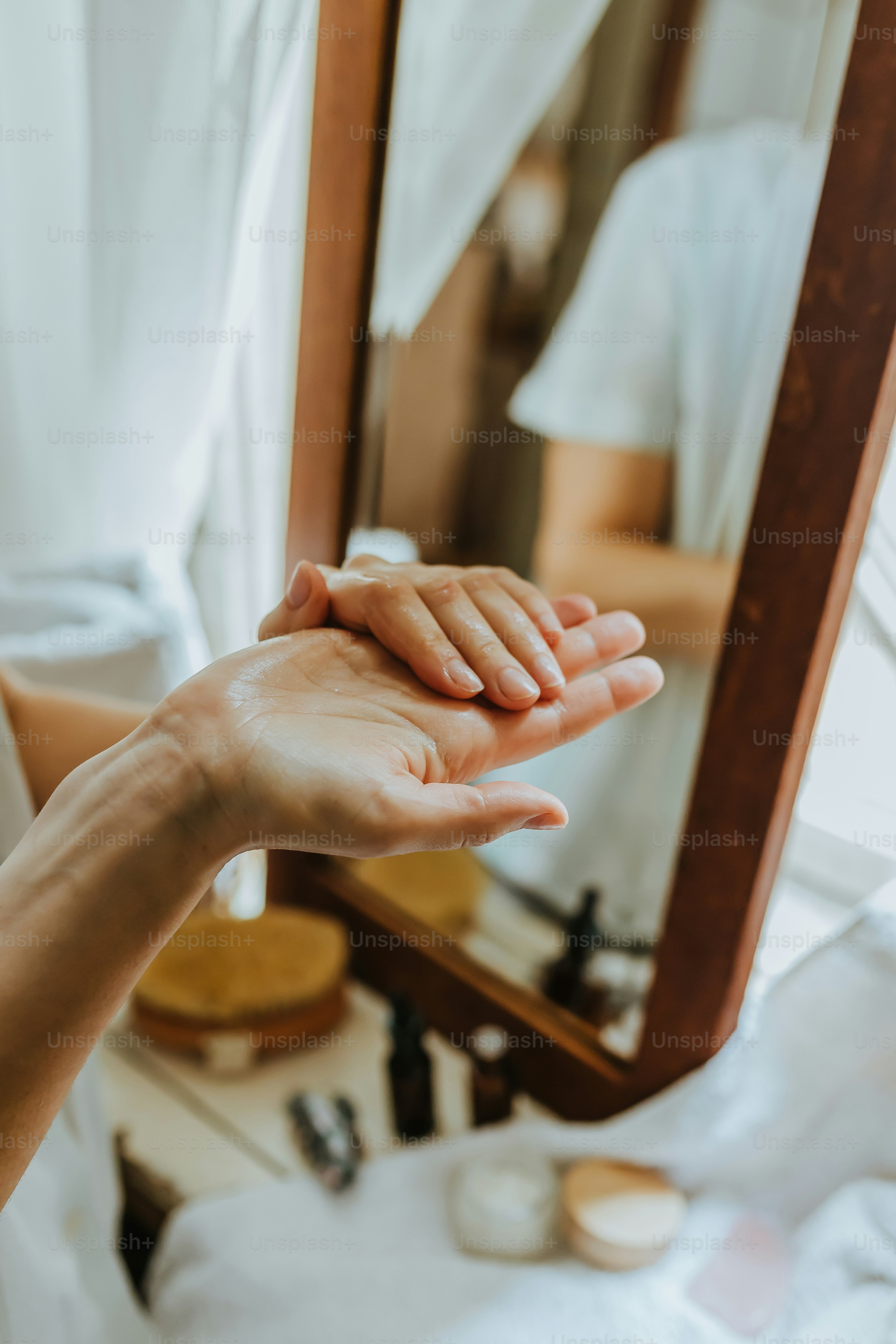 A person holding their hand out in front of a mirror photo – Skin care ...