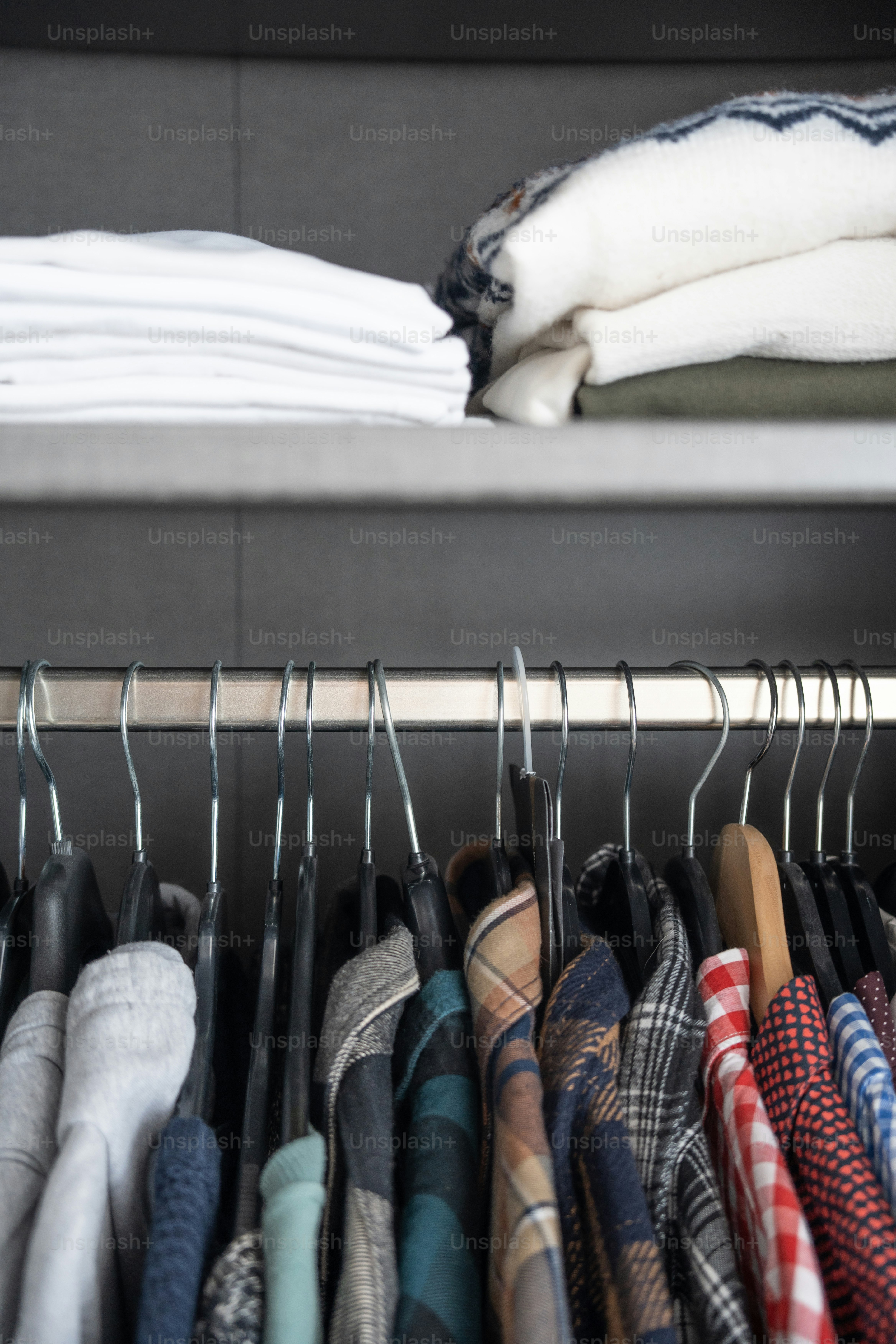A bunch of shirts hanging on a rack photo – Clothing Image on Unsplash