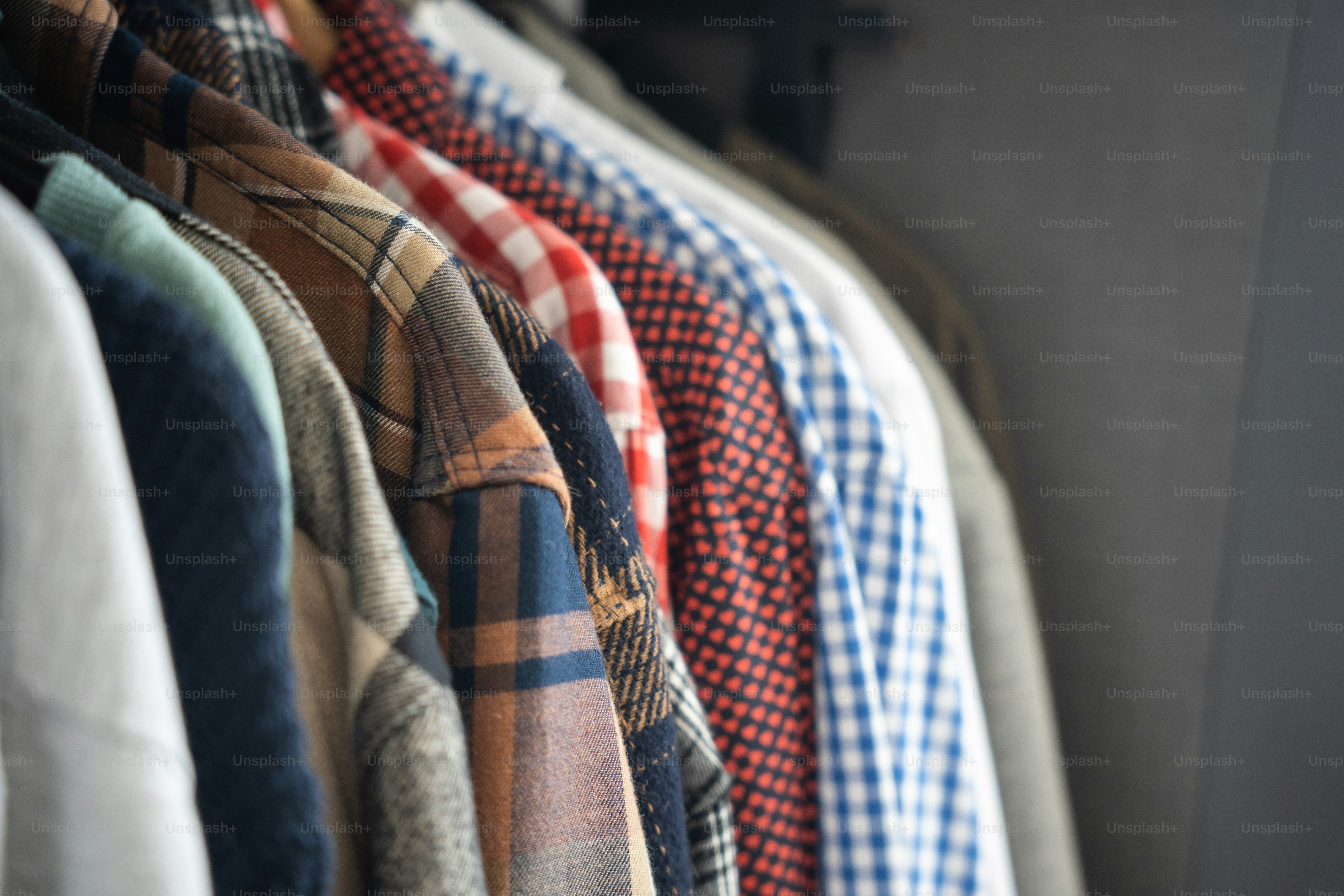 A bunch of shirts hanging on a rack photo – Closet Image on Unsplash