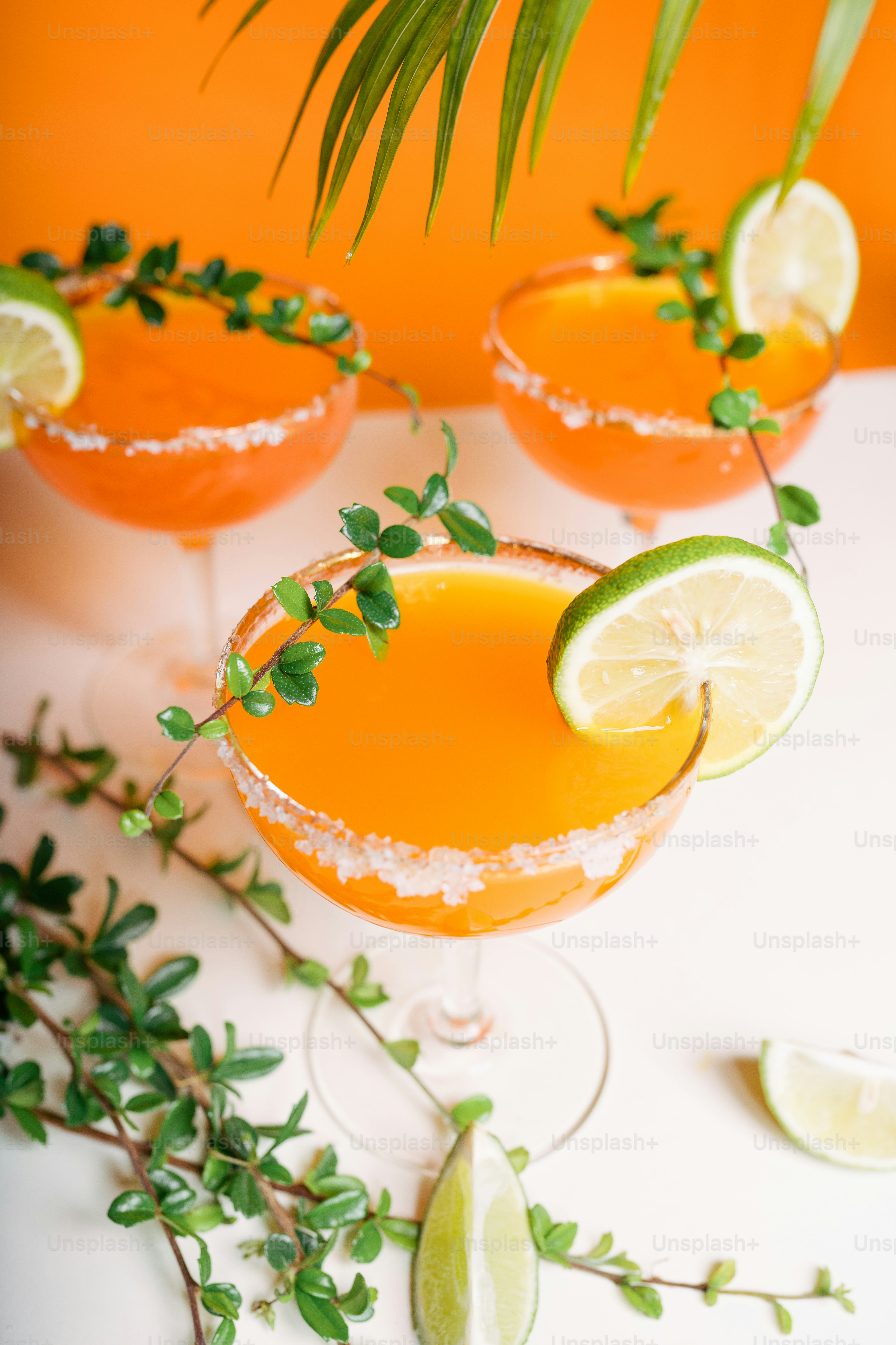 Three margaritas with limes and garnish on a table photo – Mexico Image ...