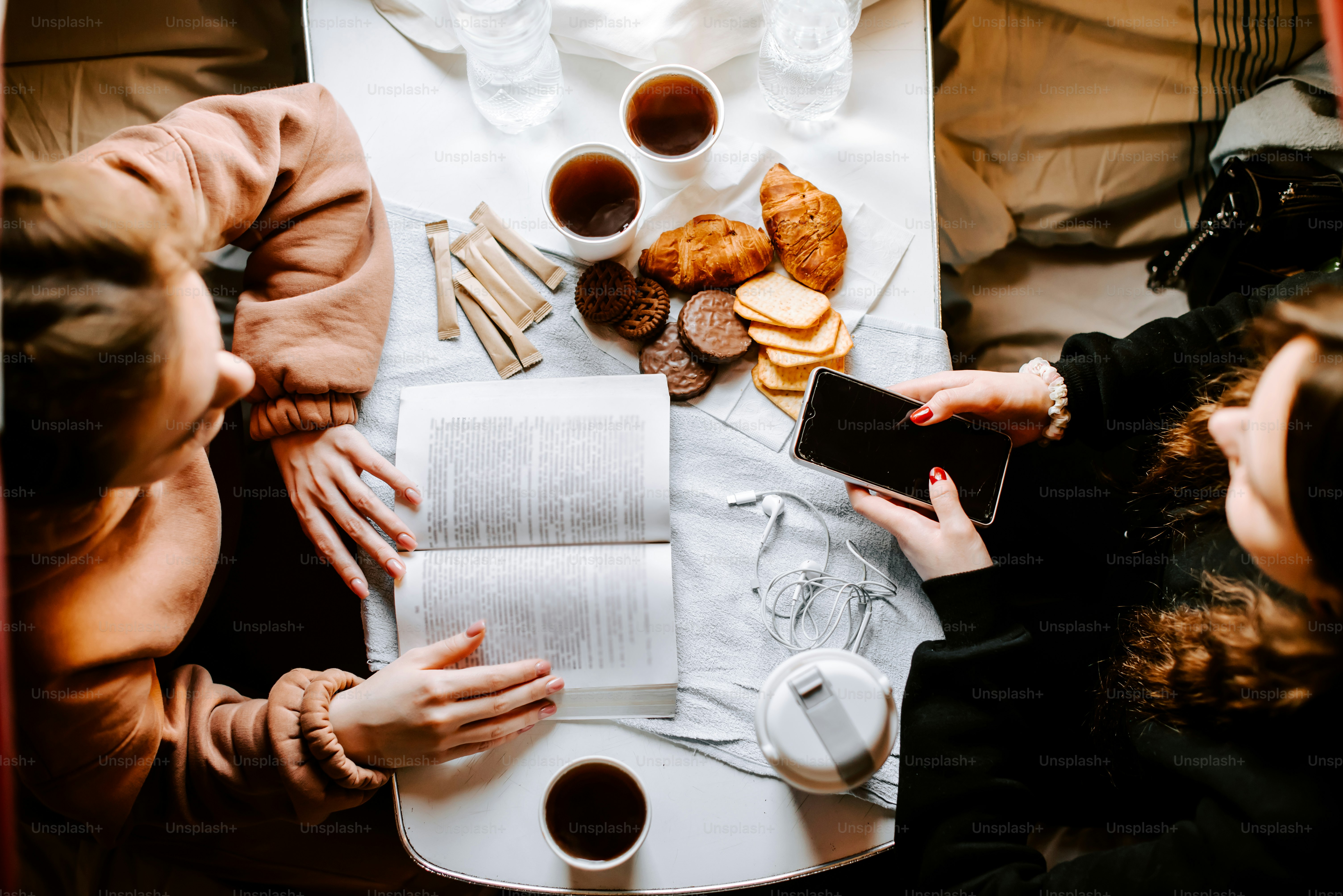 Un groupe de personnes assises autour d’une table avec de la nourriture ...