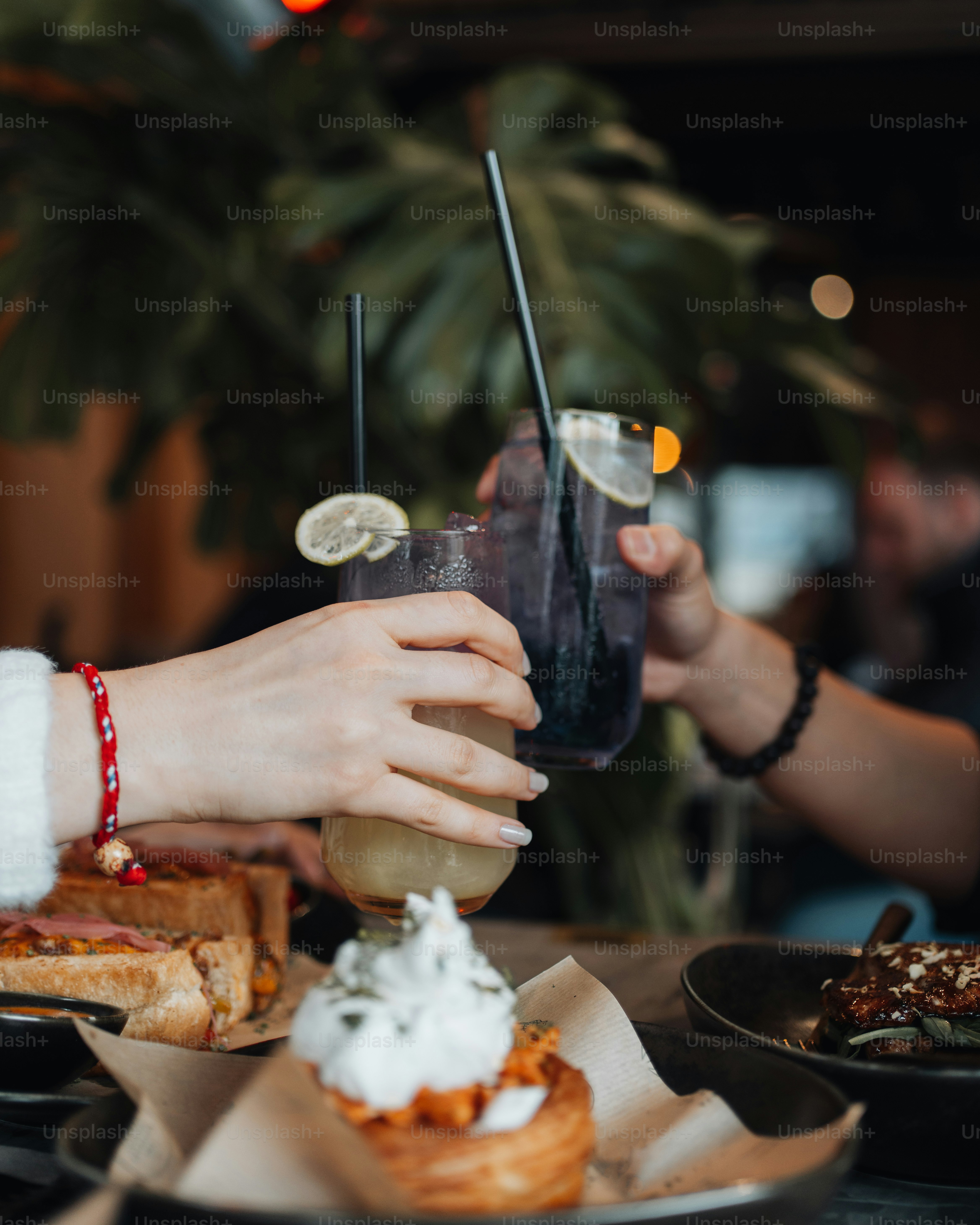 A person holding a wine glass over a plate of food photo – Restaurant ...