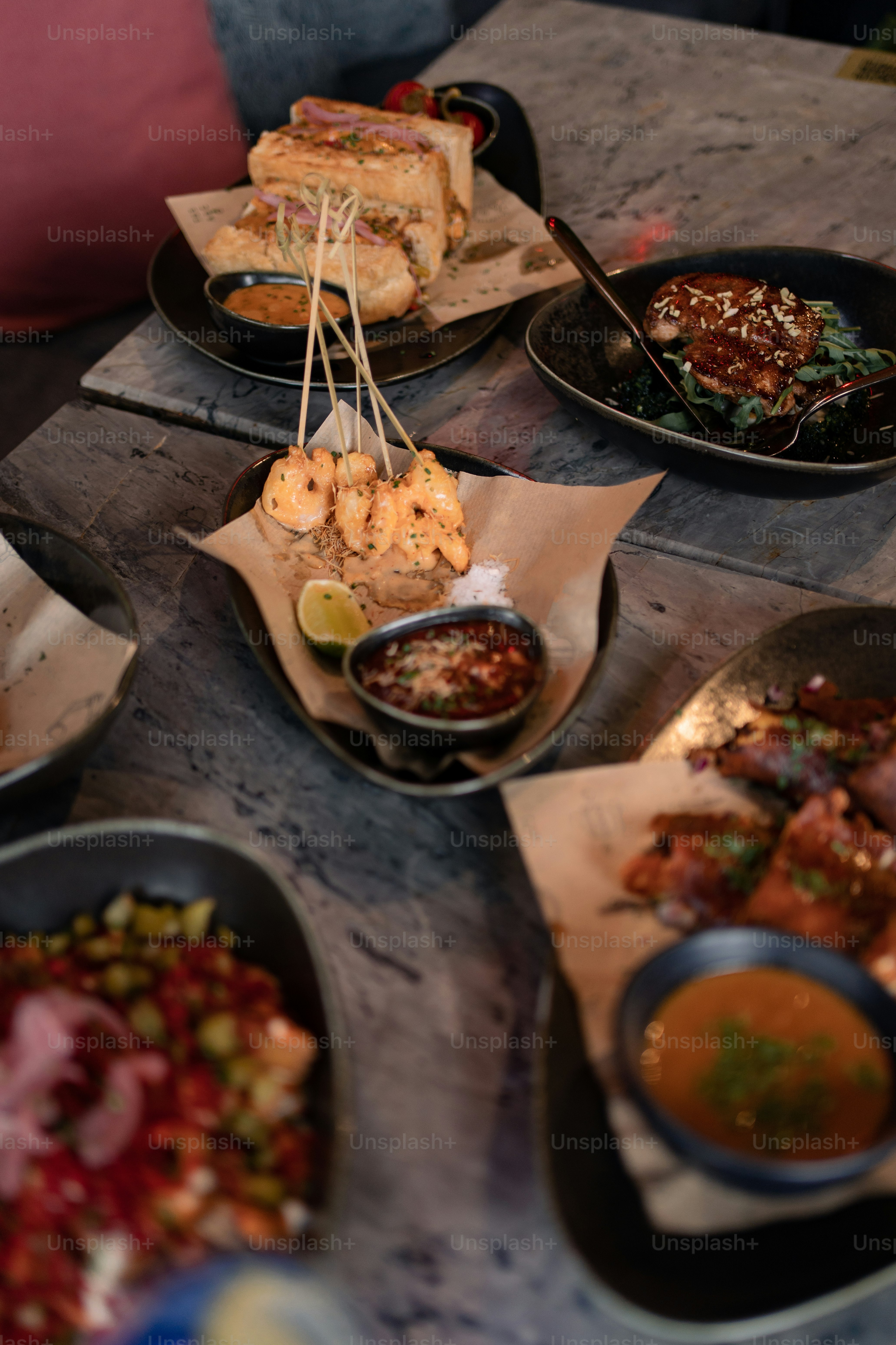 A table topped with different types of food photo – Eating out Image on ...