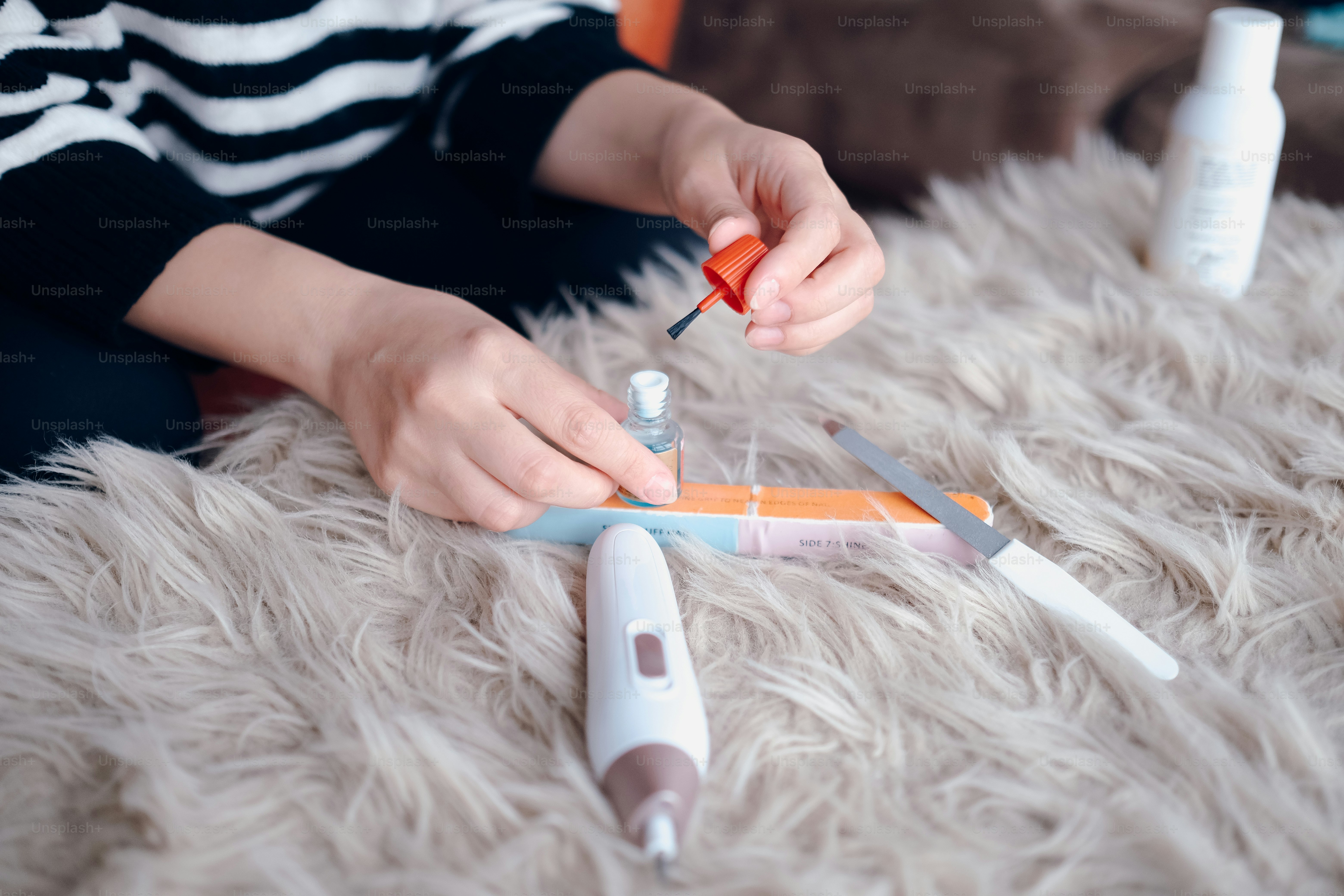 A person is doing something on the floor photo – Skin care Image on ...