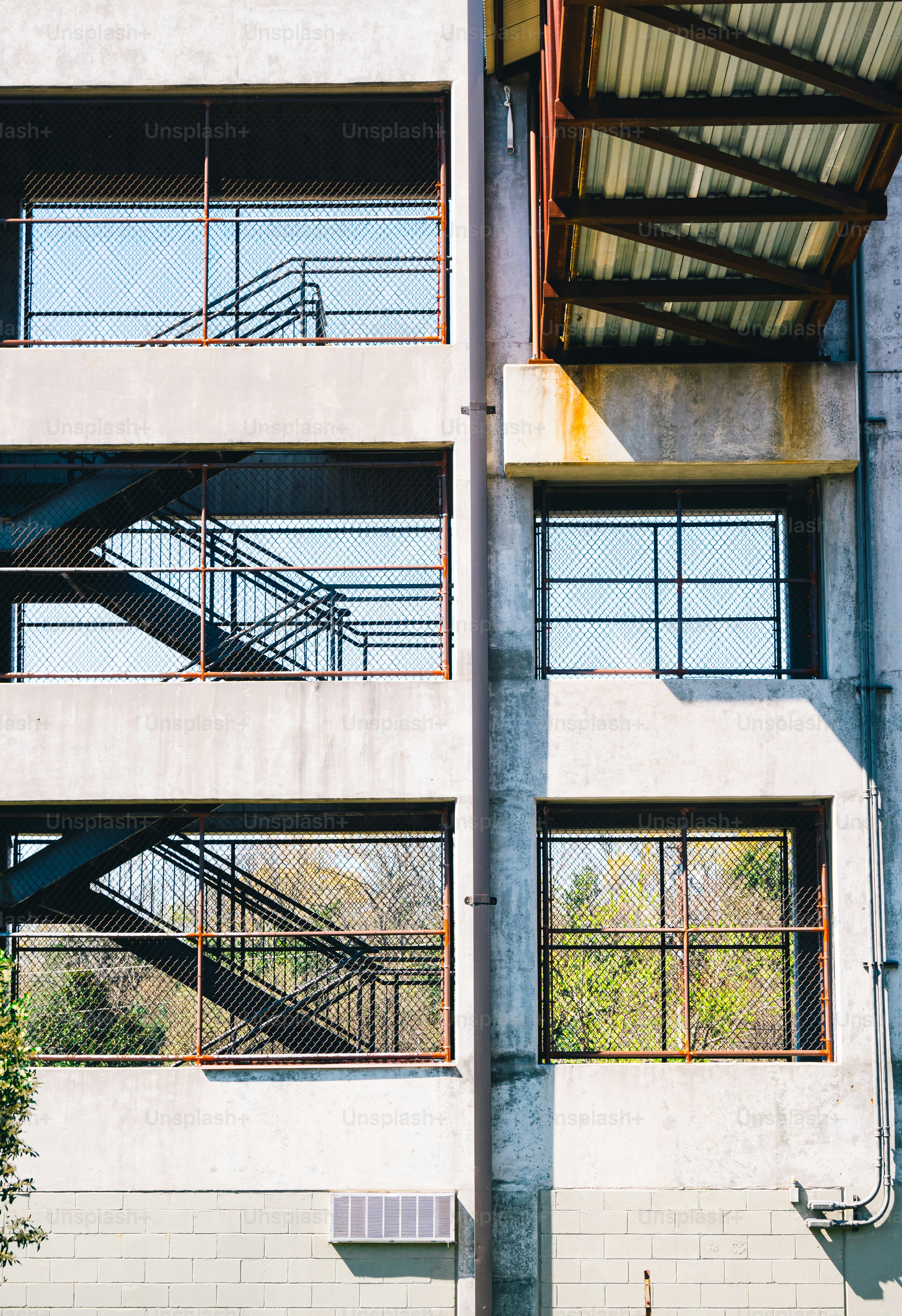 A fire hydrant sitting in front of a tall building photo – Stair case ...