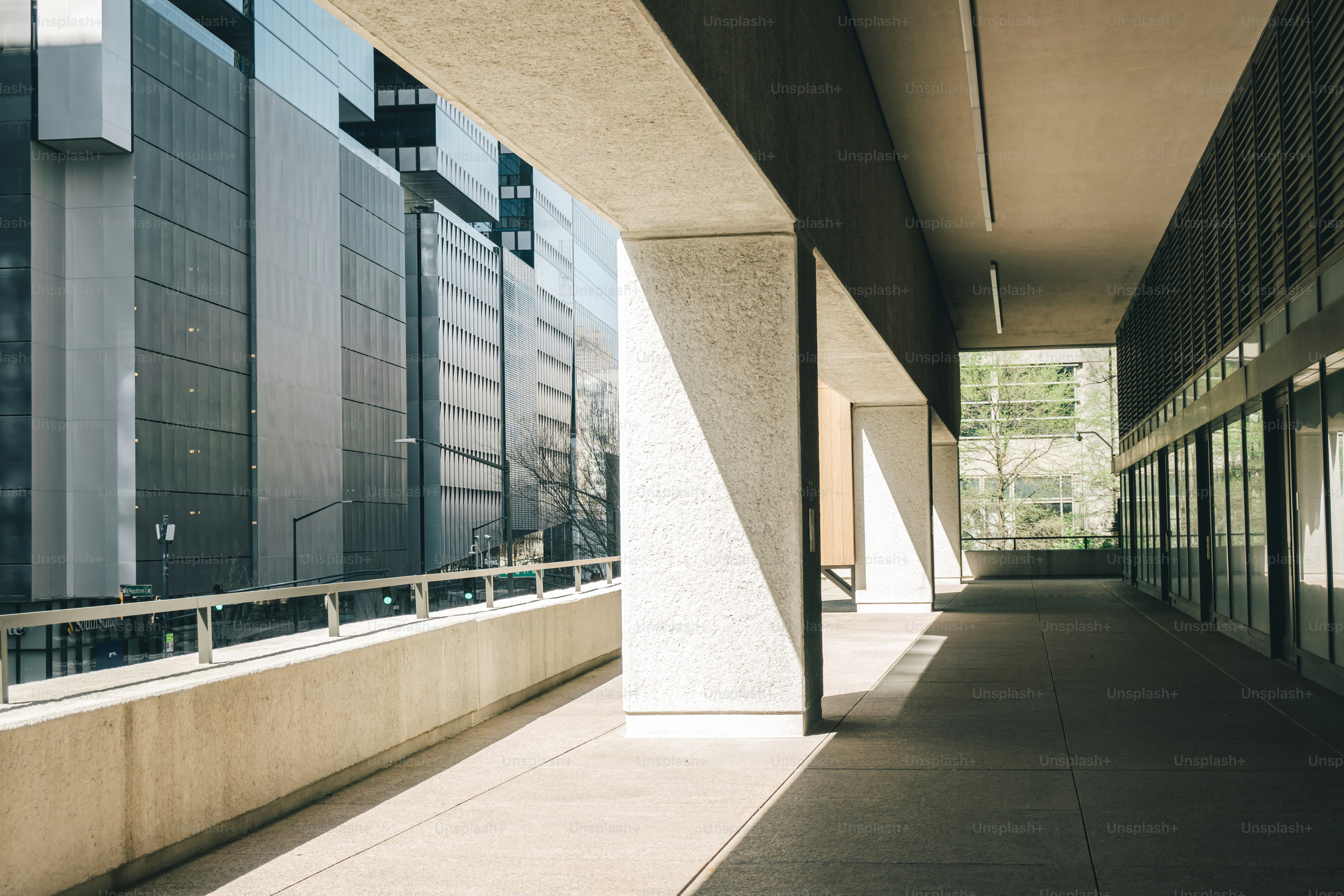 An empty walkway between two buildings in a city photo – Architecture ...
