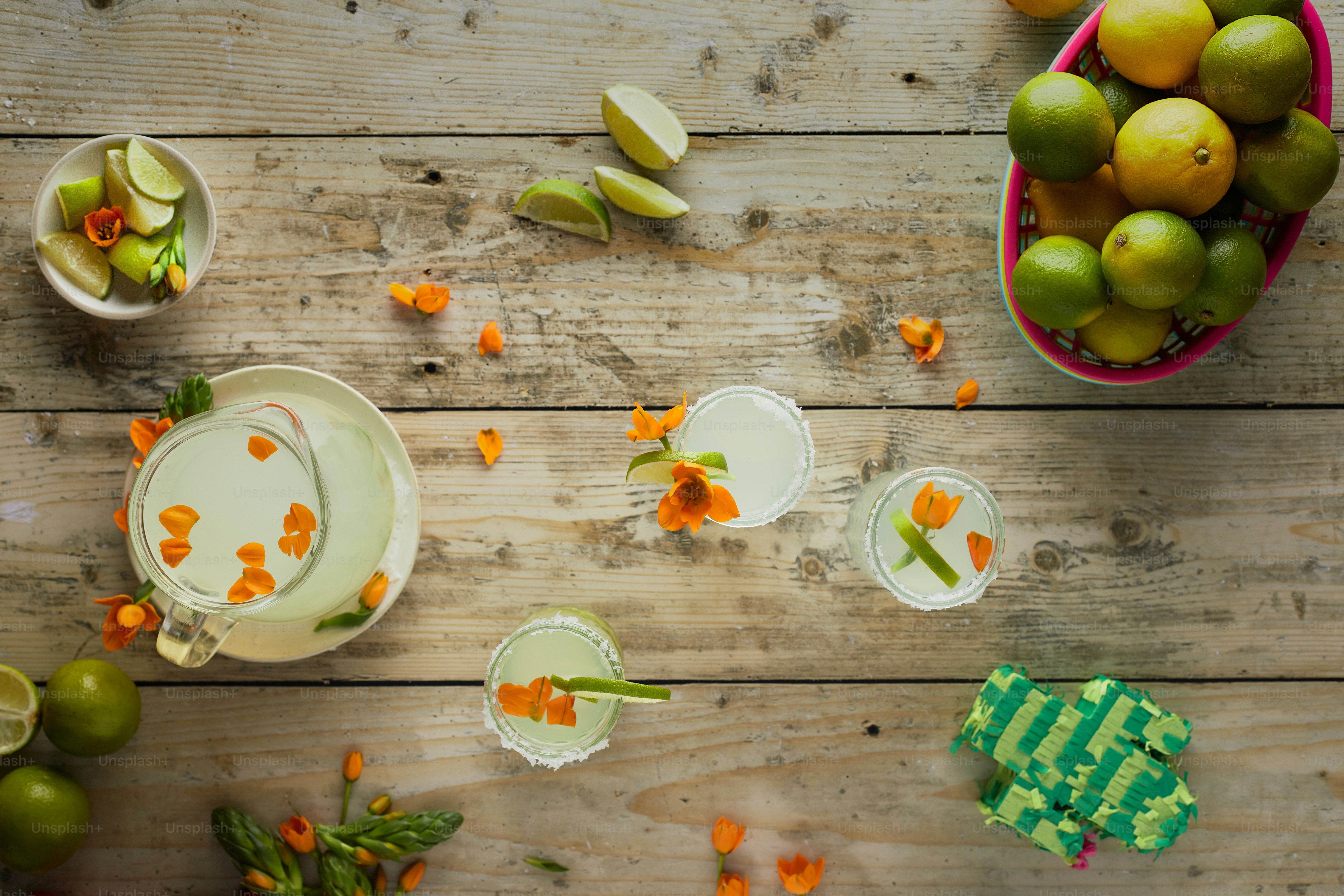 A wooden table topped with glasses filled with drinks photo – Mocktails ...