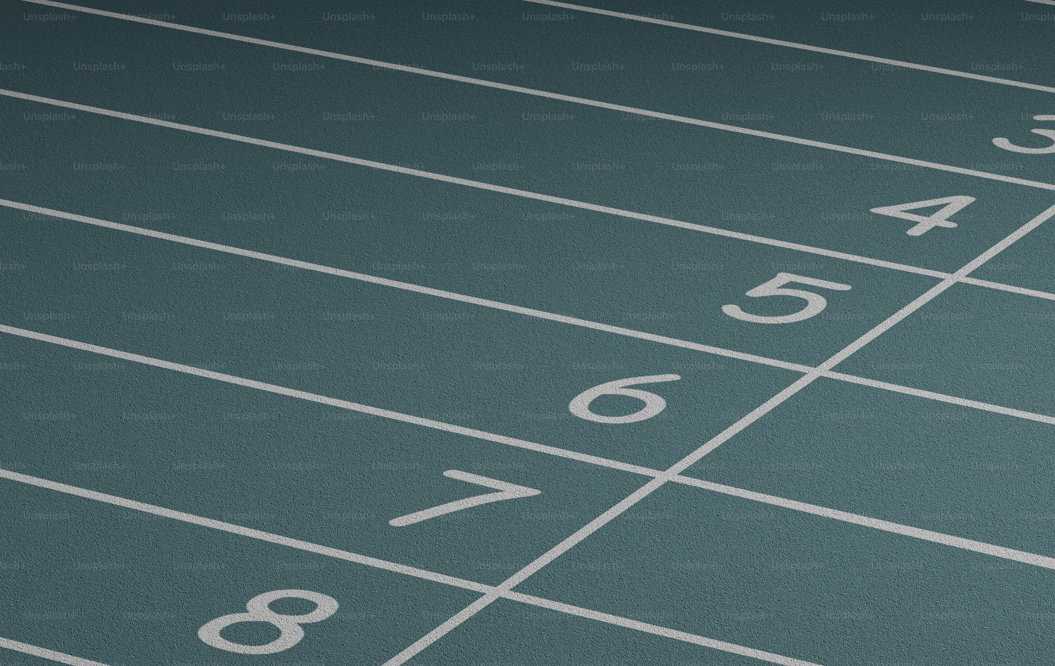 A close up of a running track with numbers on it photo – Imac wallpaper ...