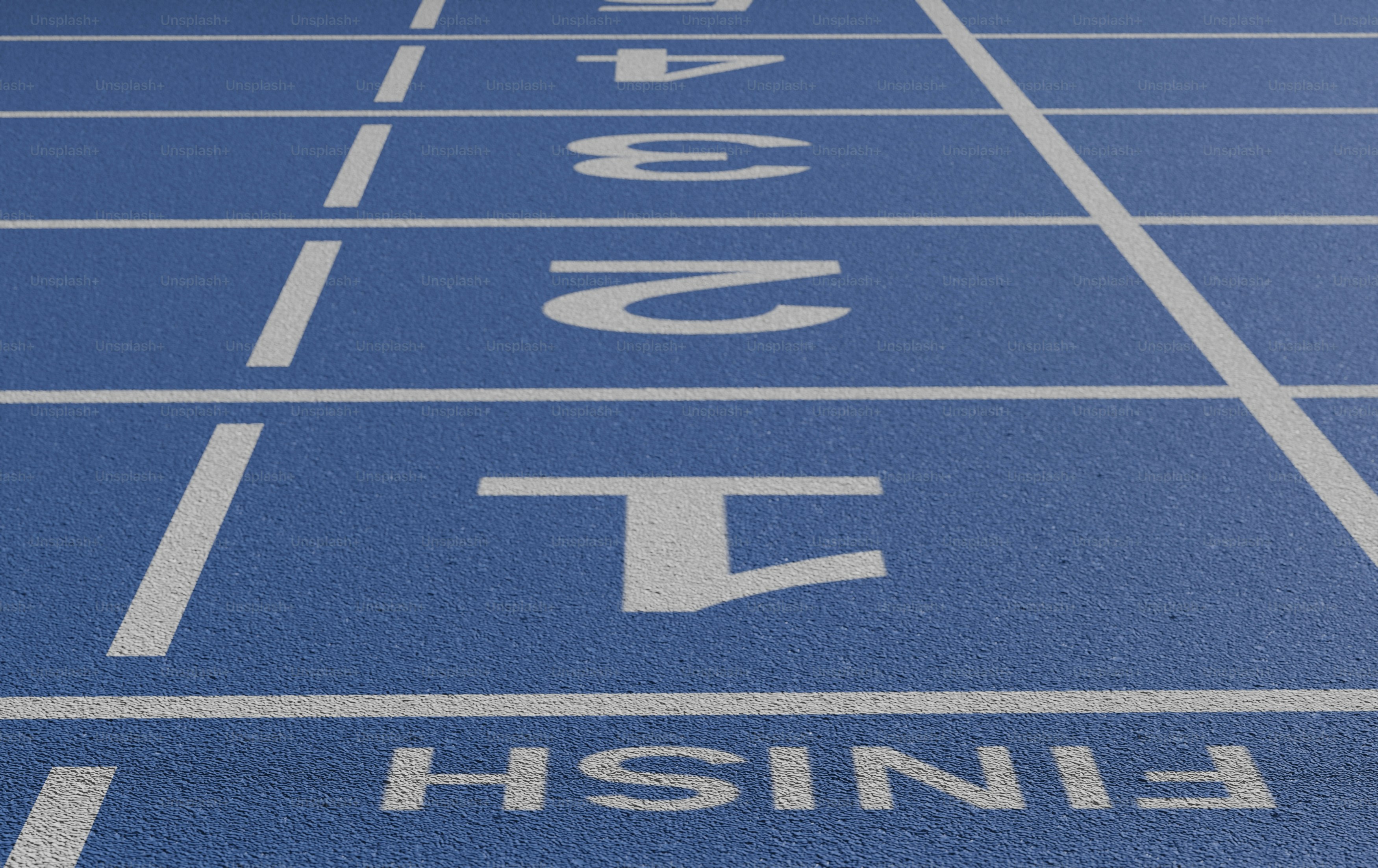 A close up of a running track with numbers on it photo – Imac wallpaper ...