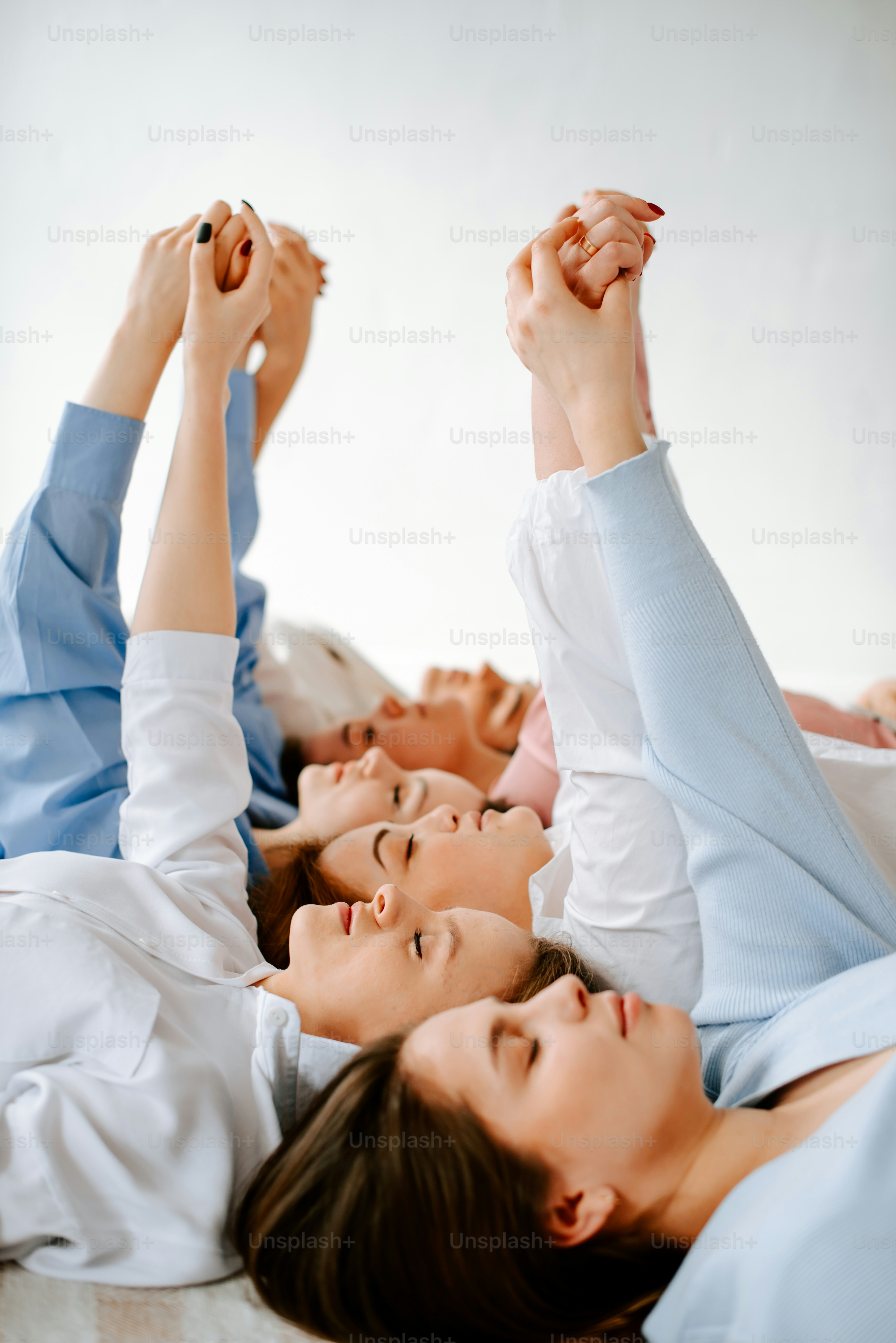A group of people laying on top of a bed photo – Female Image on Unsplash