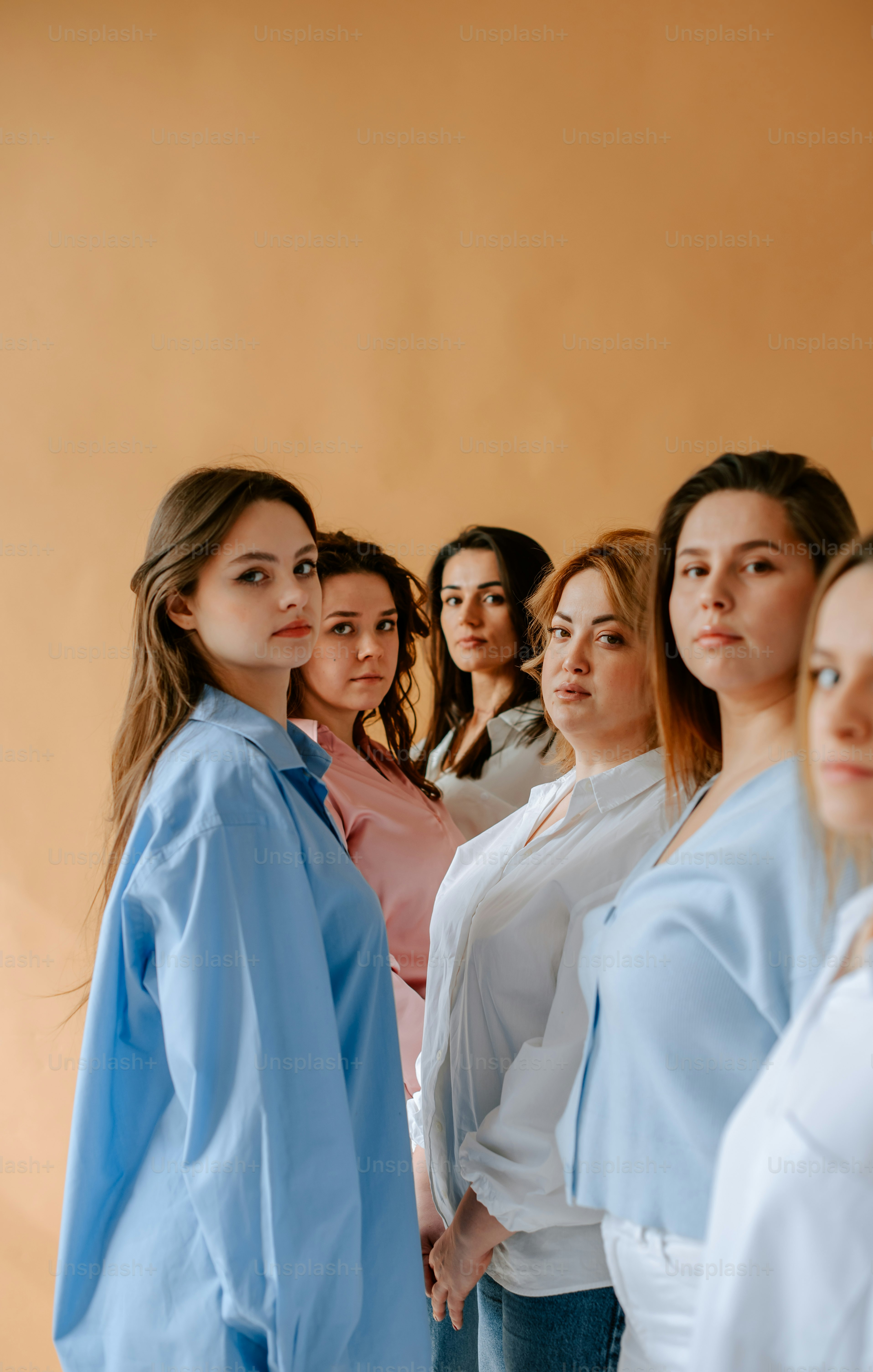 A group of women standing next to each other photo – Peer Image on Unsplash